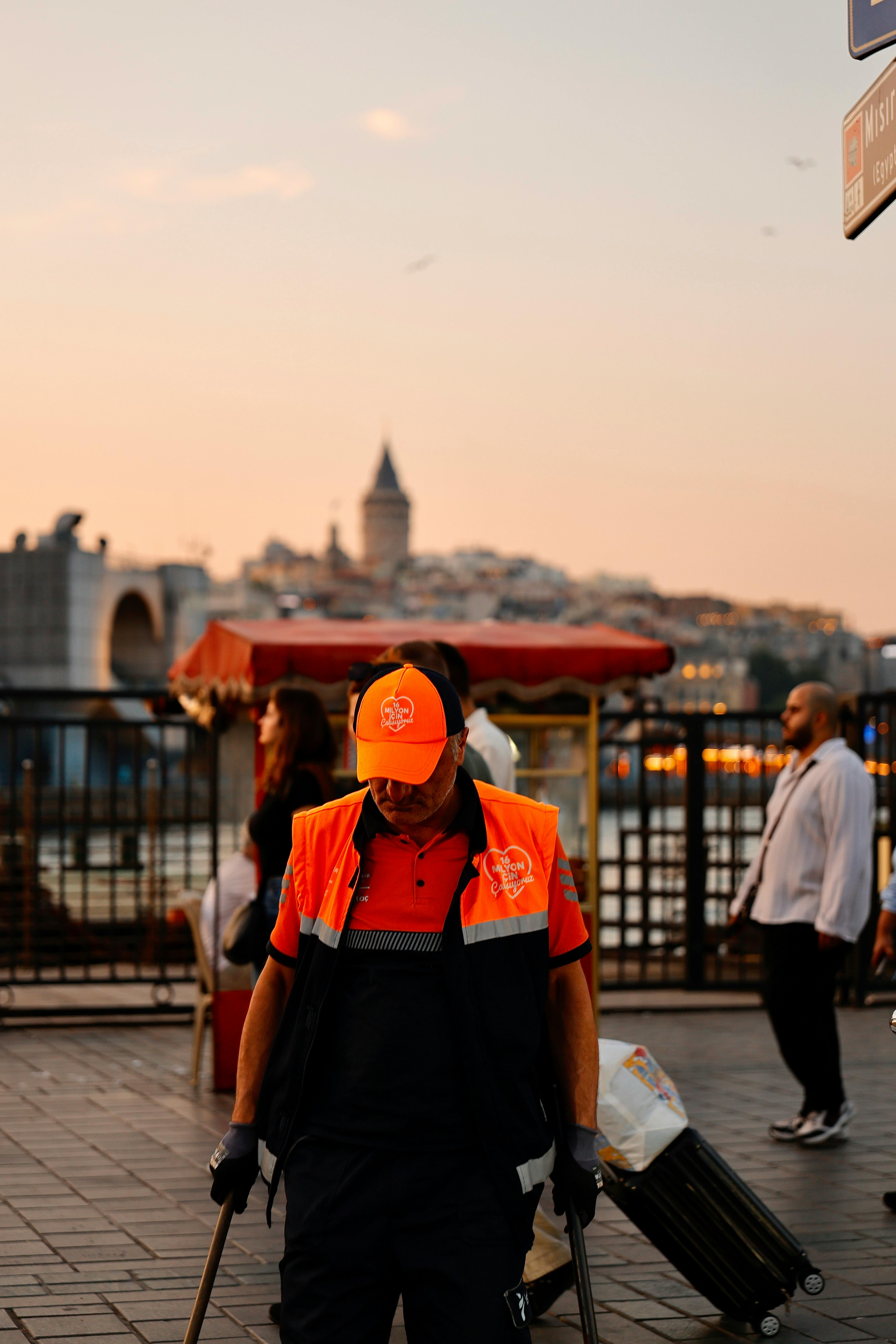 Street Cleaner at Sunset in Istanbul with Galata Tower · Free Stock Photo