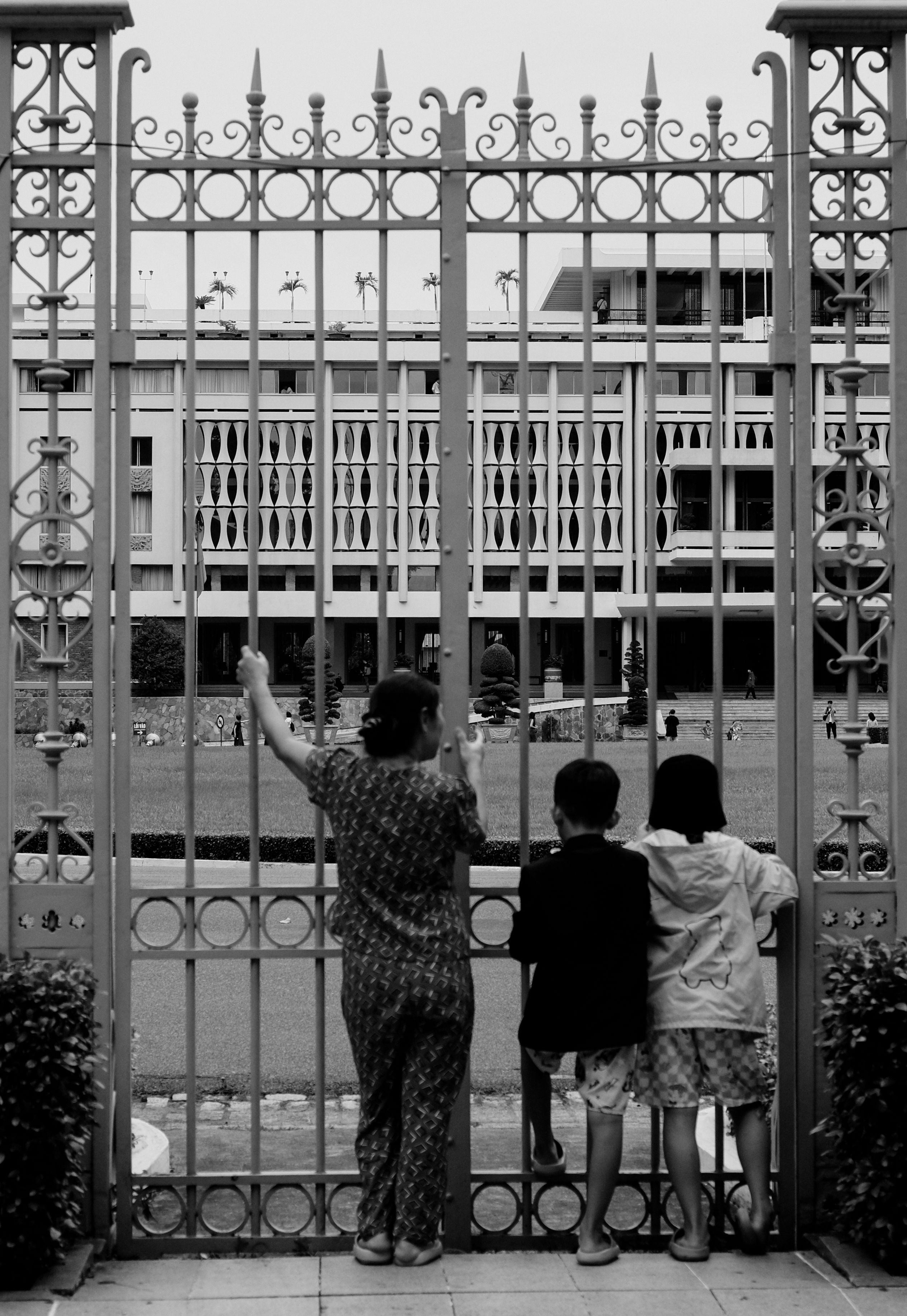 Children Viewing Historic Building Through Gate · Free Stock Photo
