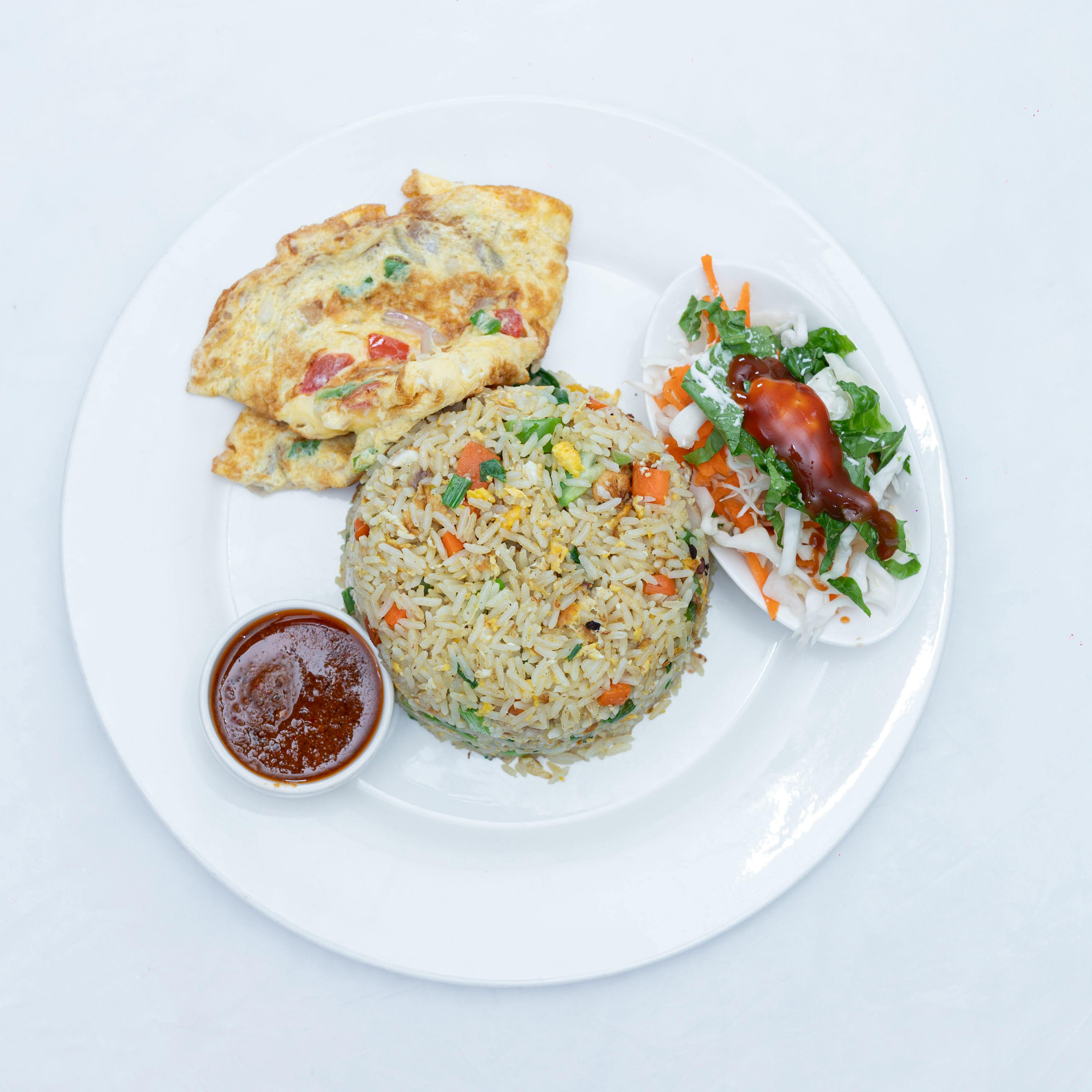 Delicious Ghanaian Fried Rice Dish with Garnish · Free Stock Photo