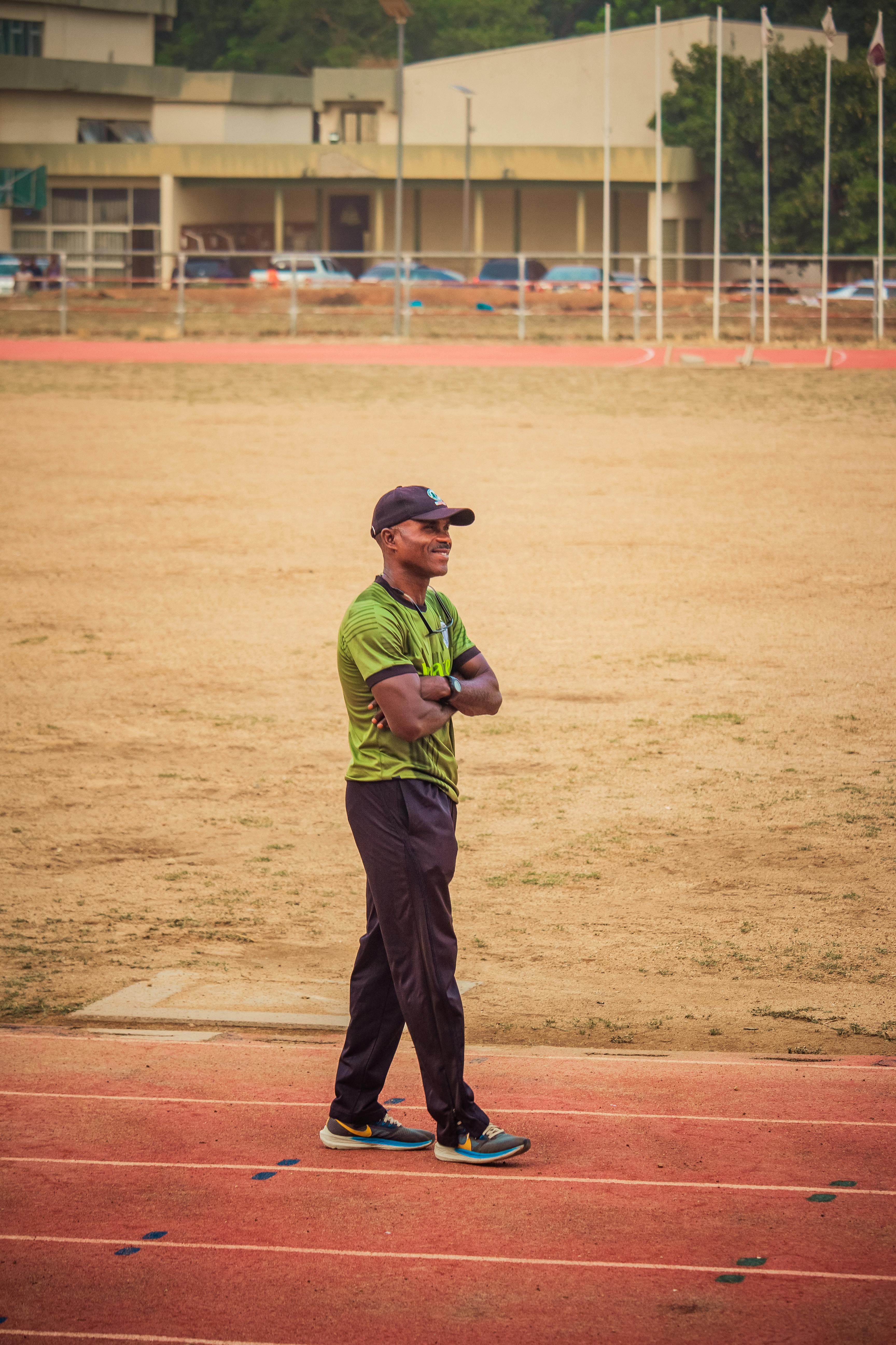 Athletic Coach Observing on Running Track · Free Stock Photo