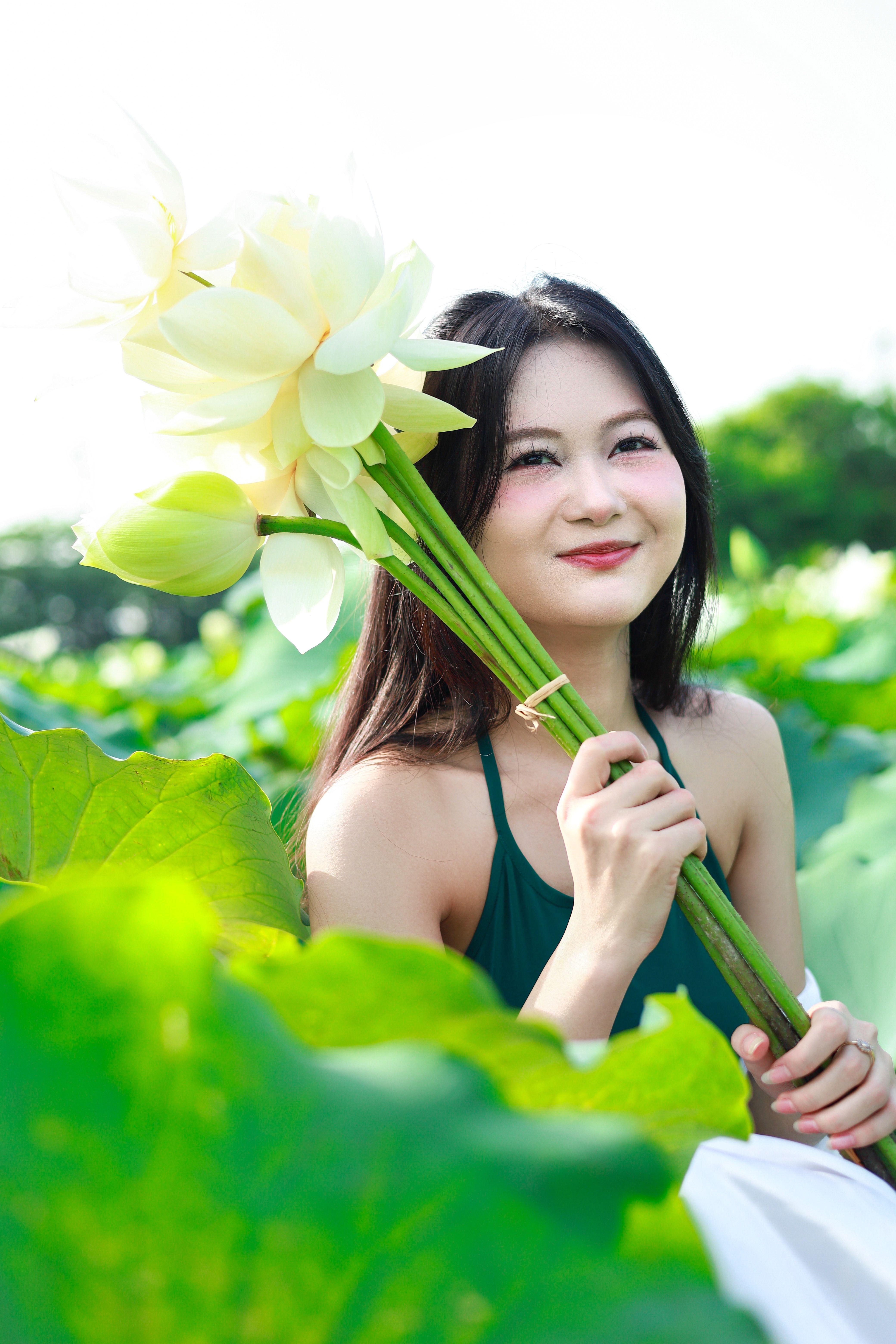 Young Woman Holding White Lotus Flowers in Vietnam Lotus Field · Free ...