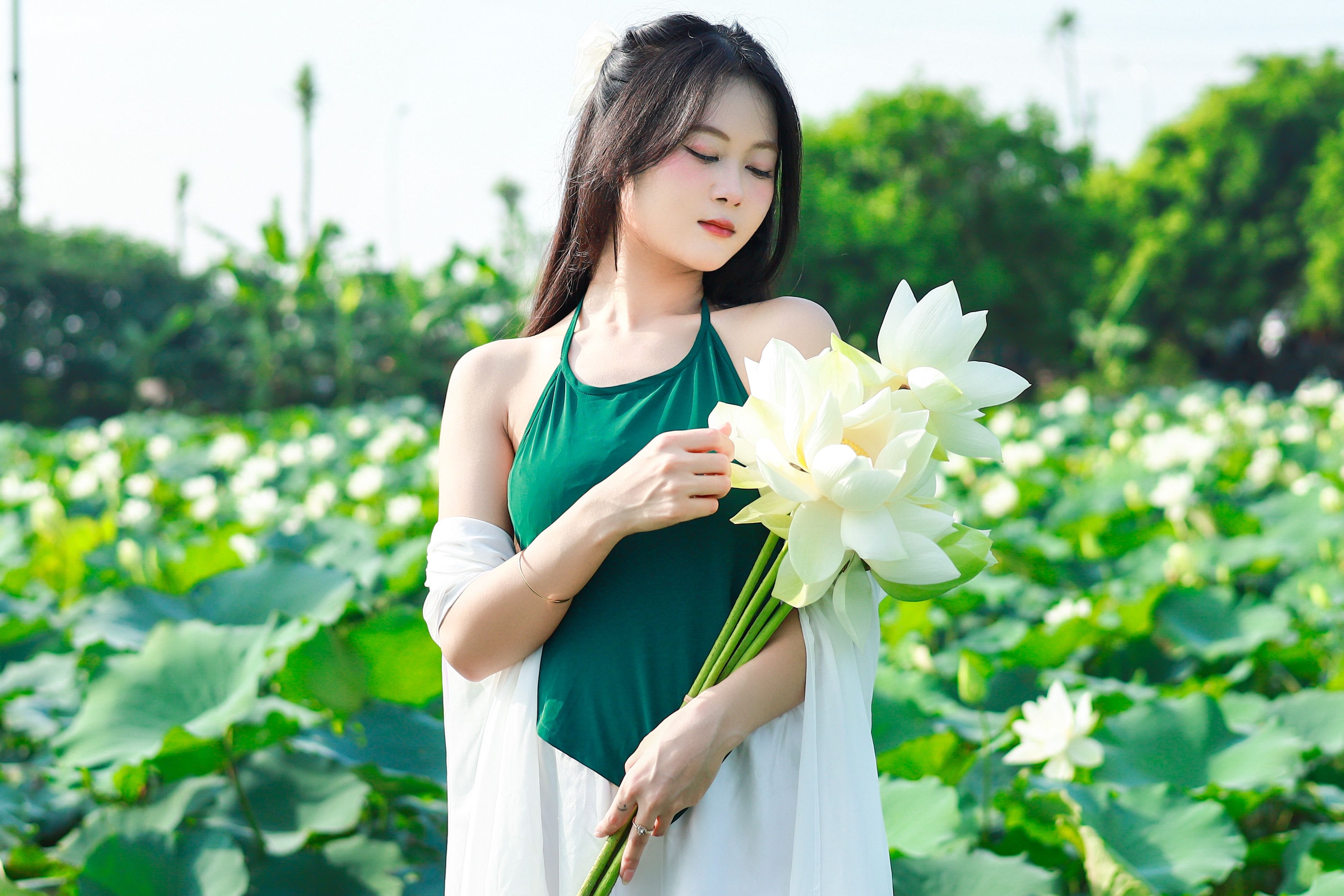 Woman Holding Lotus Flowers in Vietnamese Field · Free Stock Photo