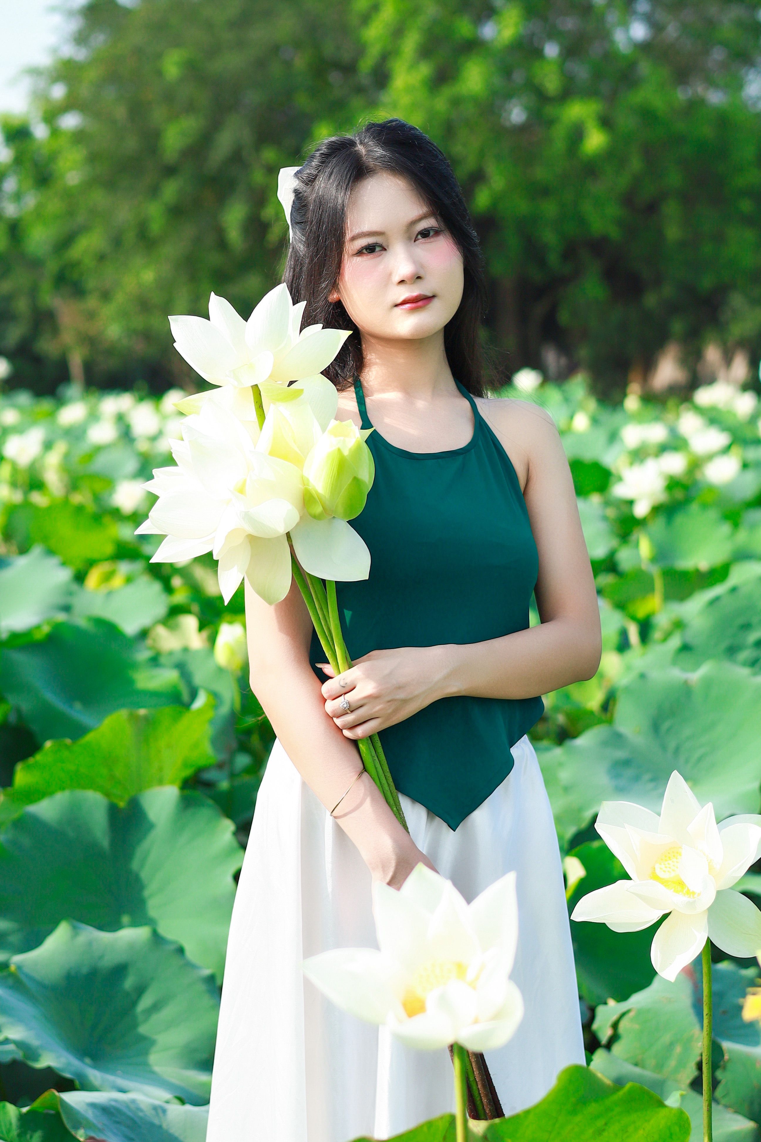 Woman Posing with White Lotus Flowers in Vietnam · Free Stock Photo