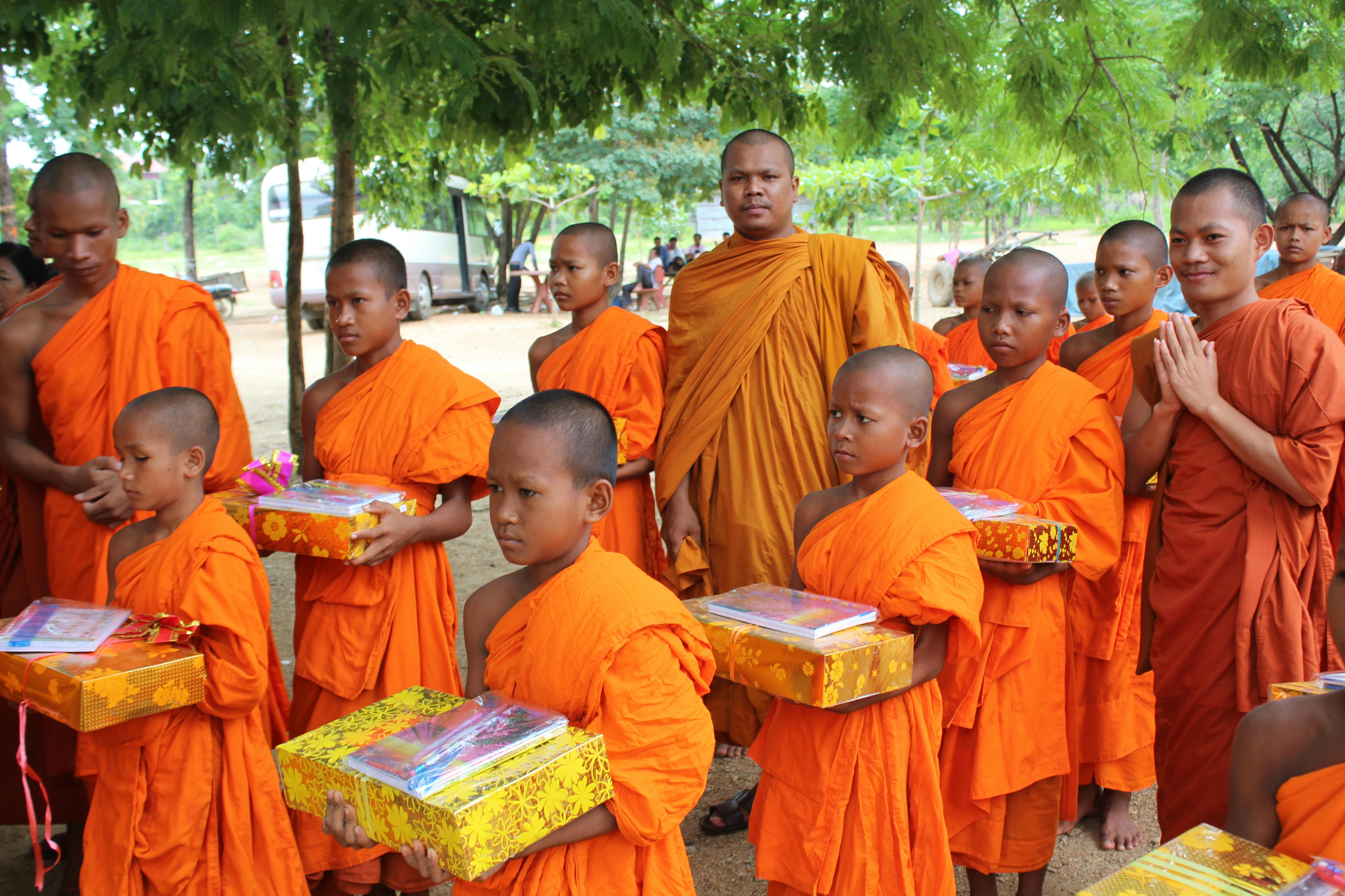 Young Monks with Gifts in Cambodian Ceremony · Free Stock Photo