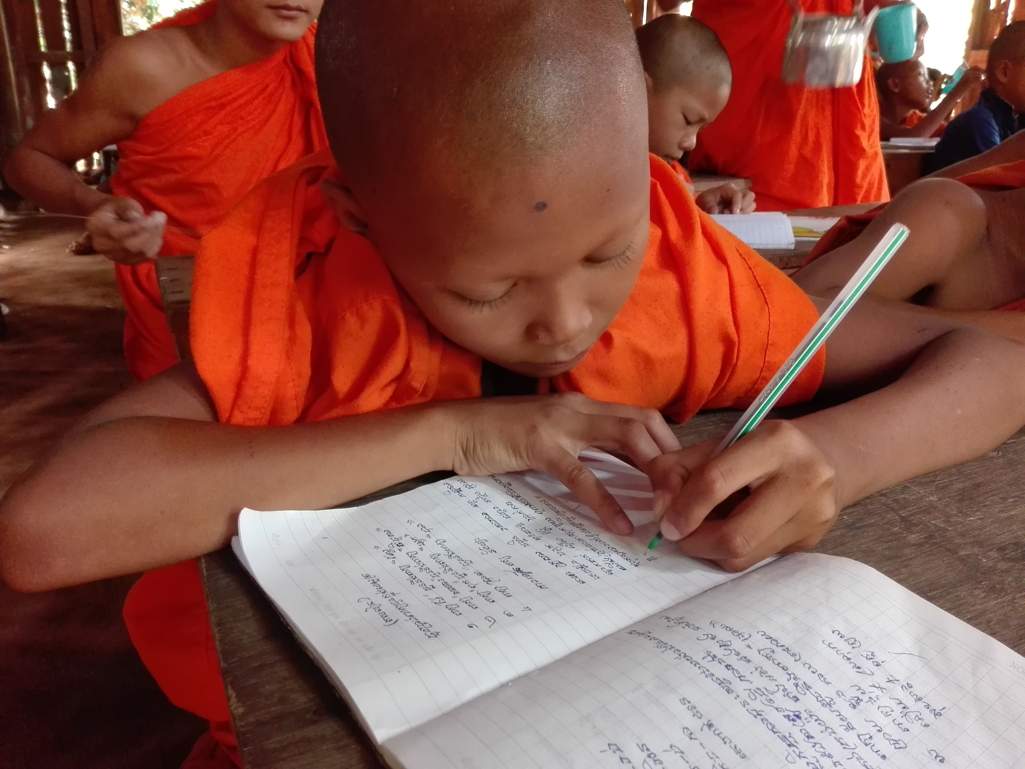 Young Monk Writing in Classroom in Cambodia · Free Stock Photo