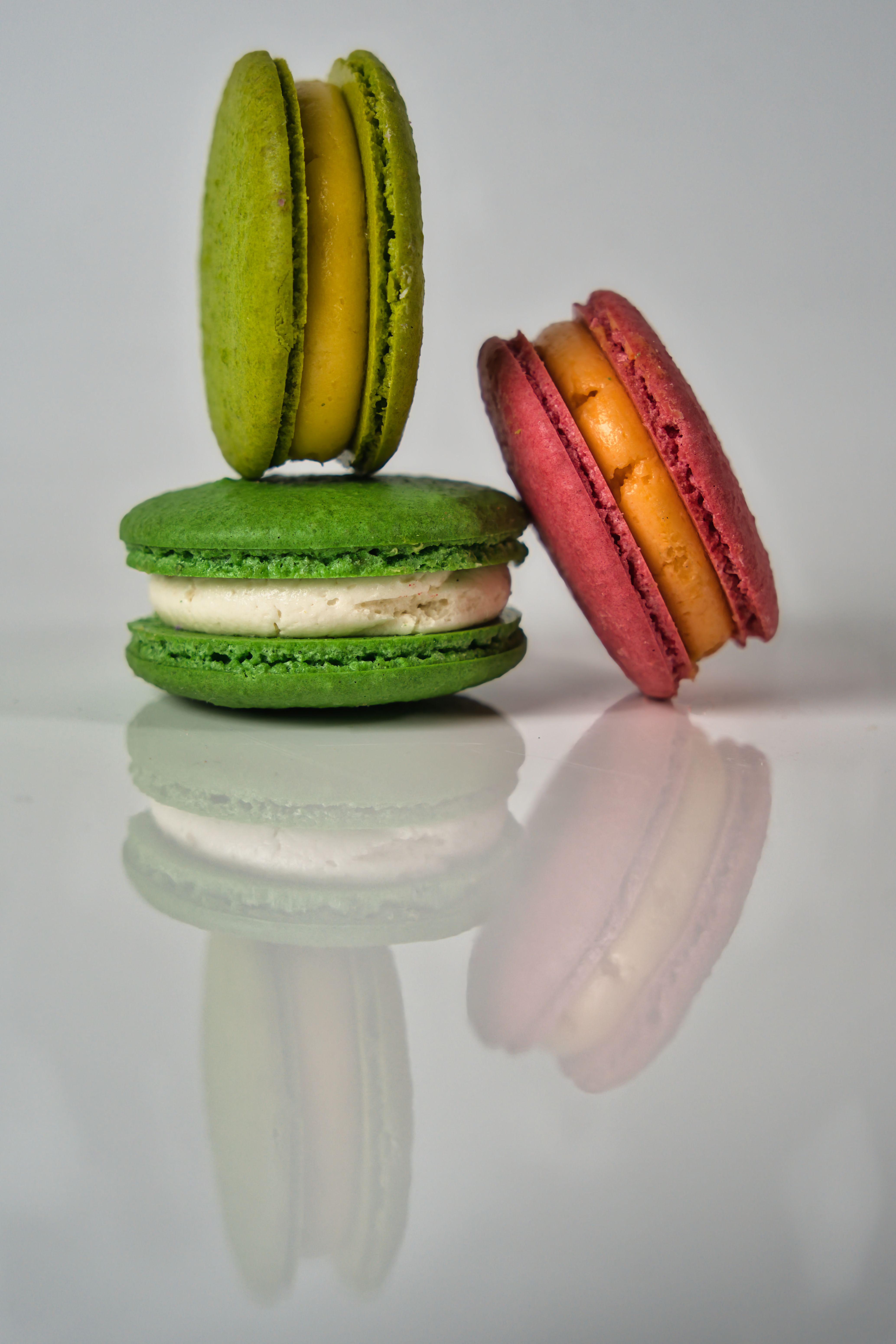 Colorful French Macarons on Reflective Surface · Free Stock Photo