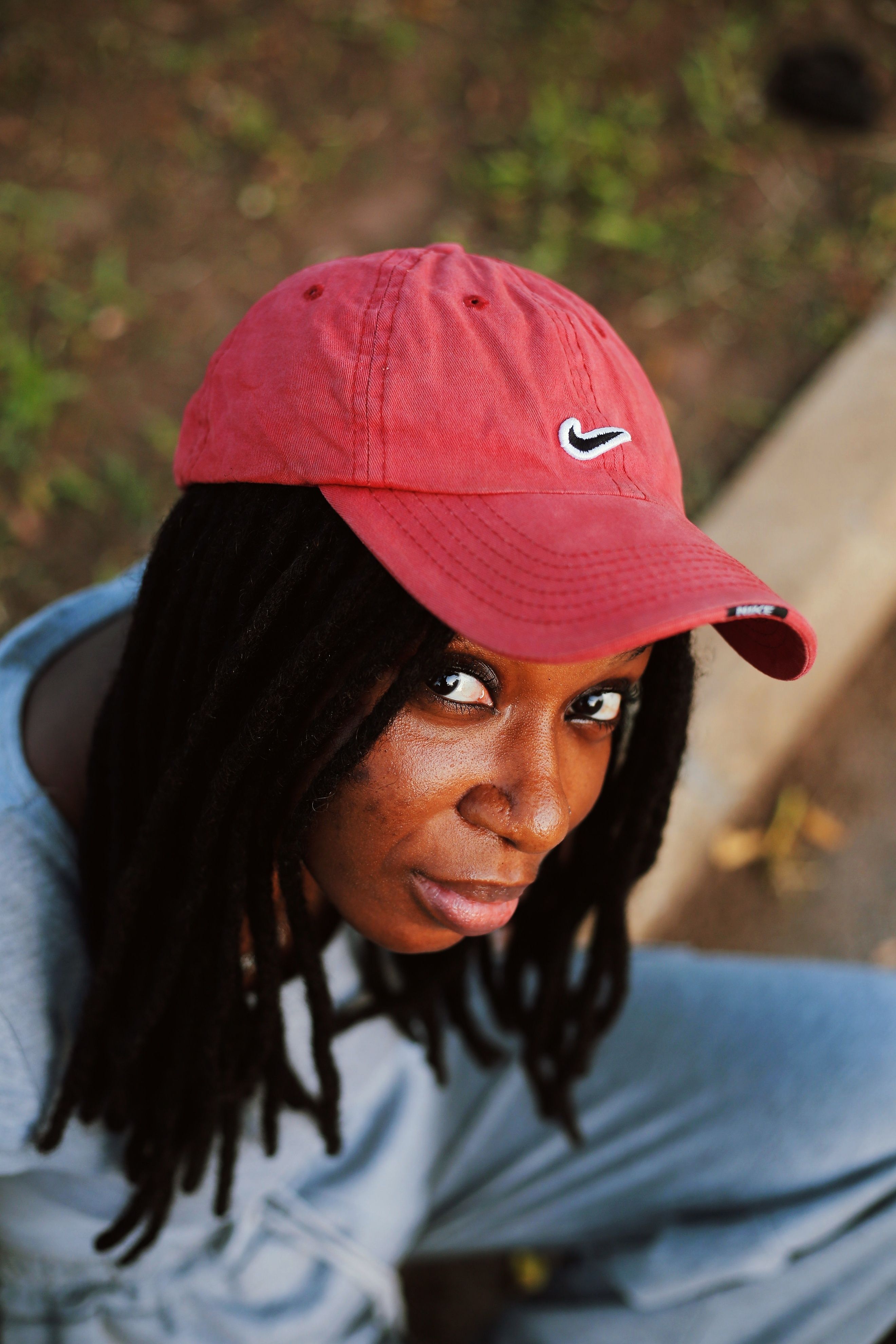 Portrait of a Woman in Red Cap Outdoors in Abuja · Free Stock Photo