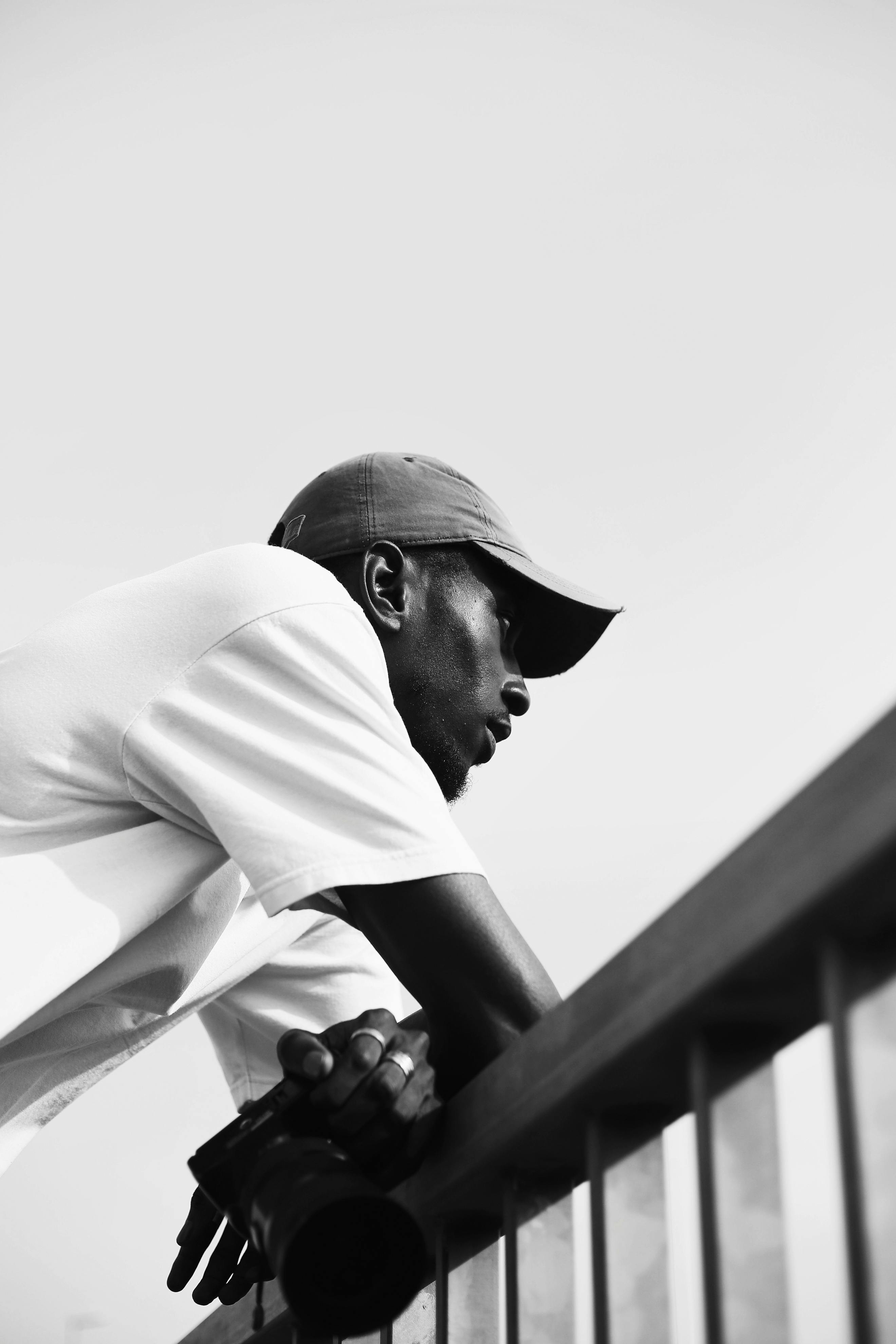 Thoughtful Man Resting on Rail in Abuja · Free Stock Photo