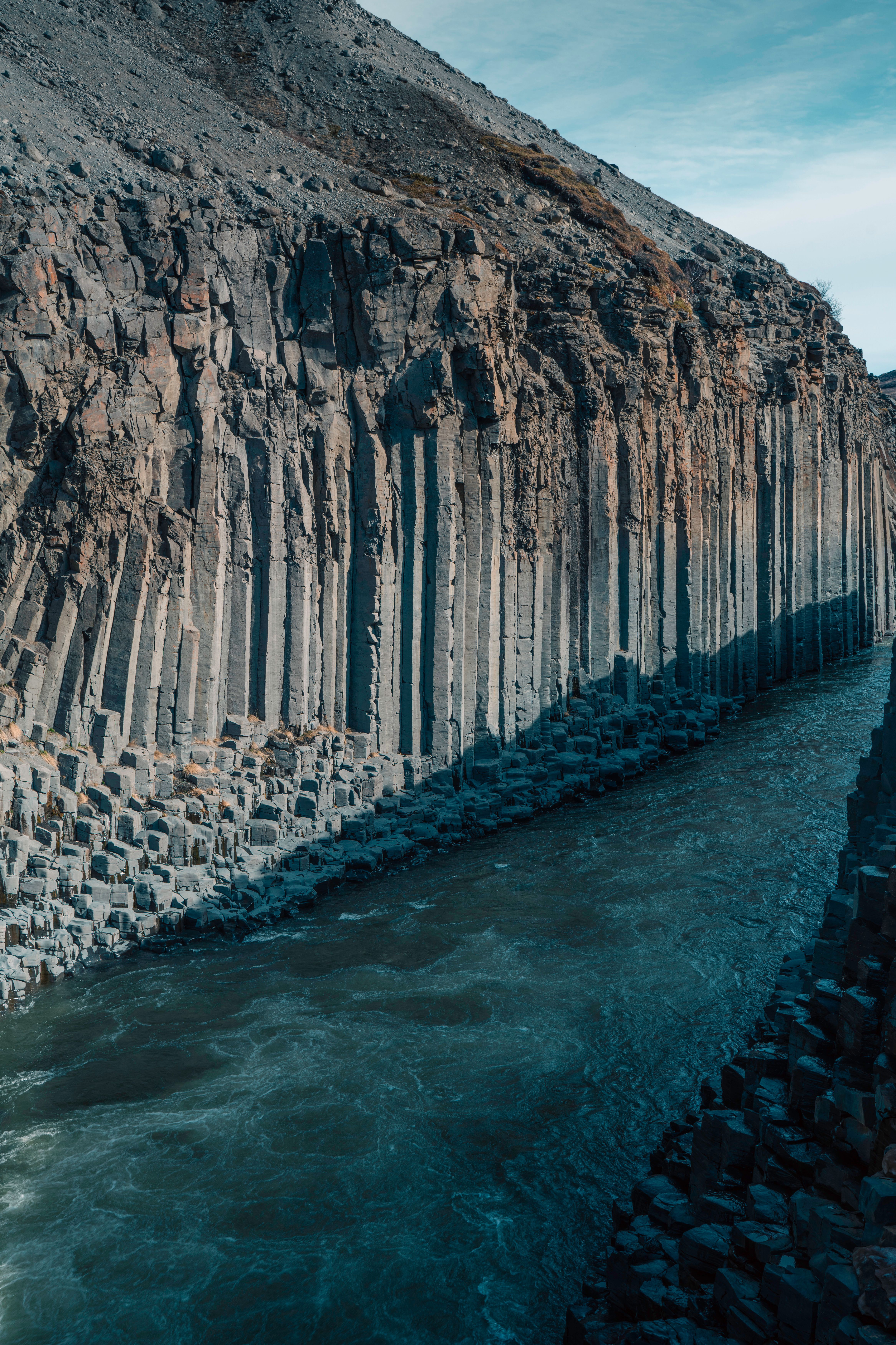 Majestic Basalt Columns Along Icelandic River · Free Stock Photo
