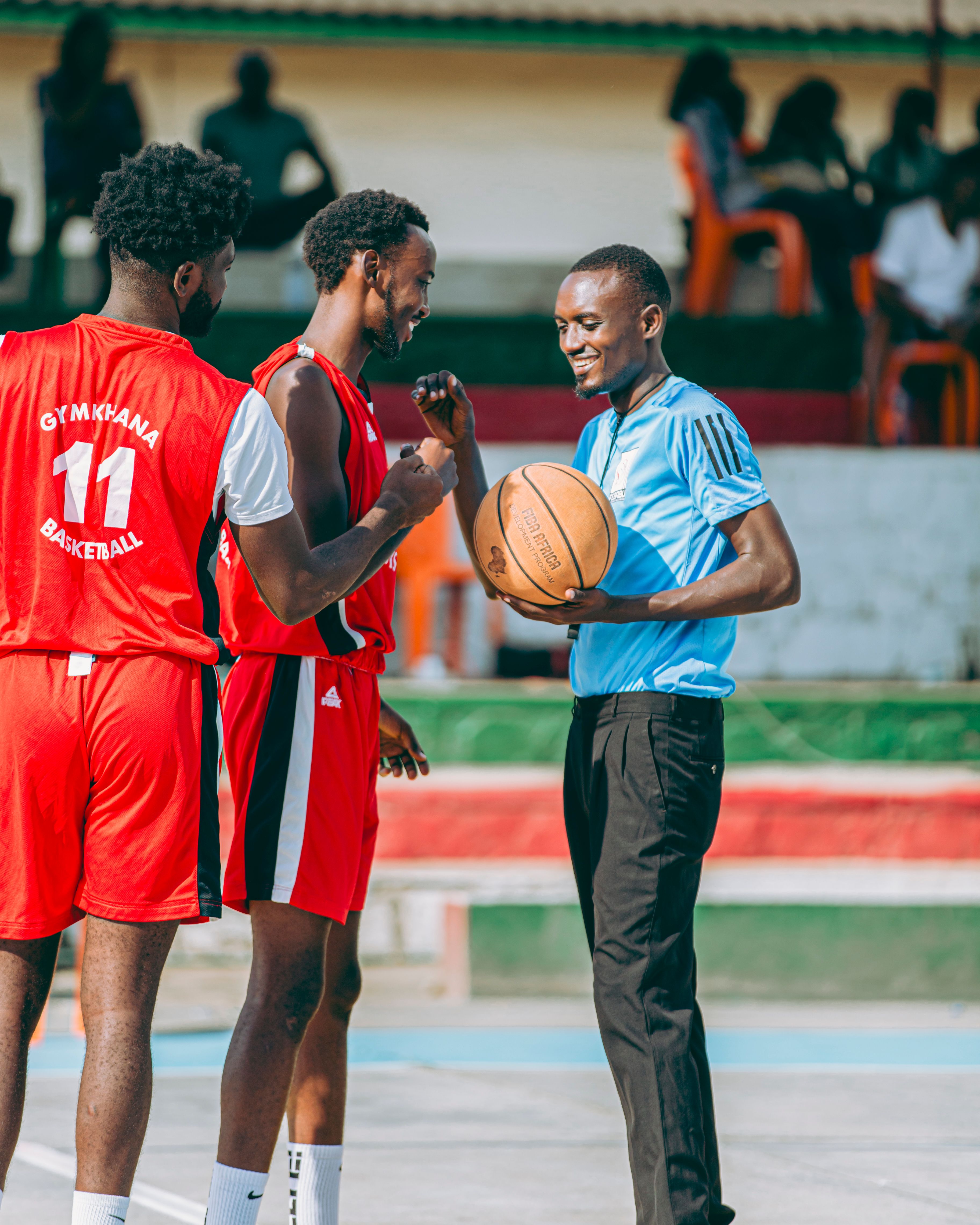 Basketball Coach Motivating Players on Court · Free Stock Photo