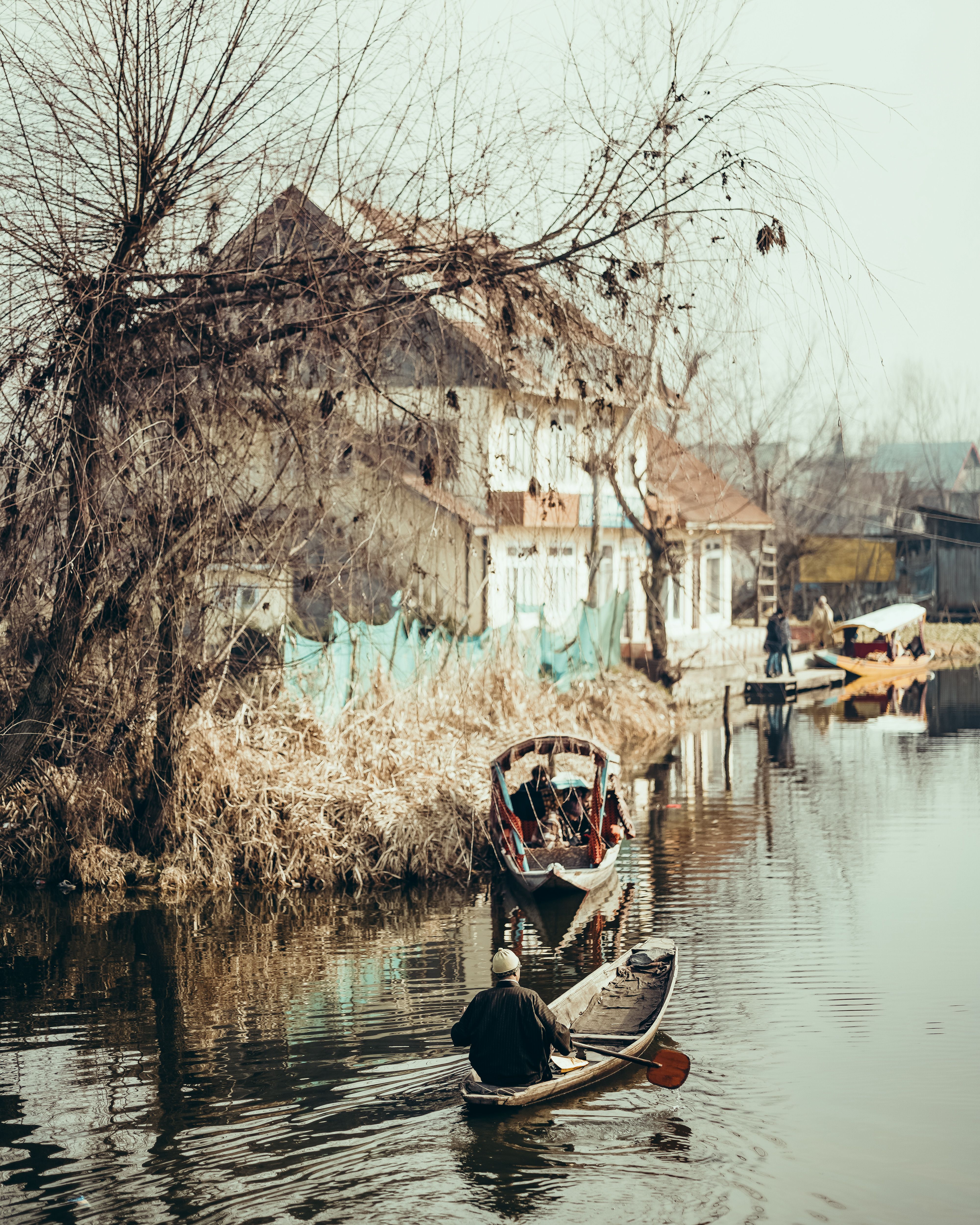 Rustic River Scene with Traditional Canoe · Free Stock Photo