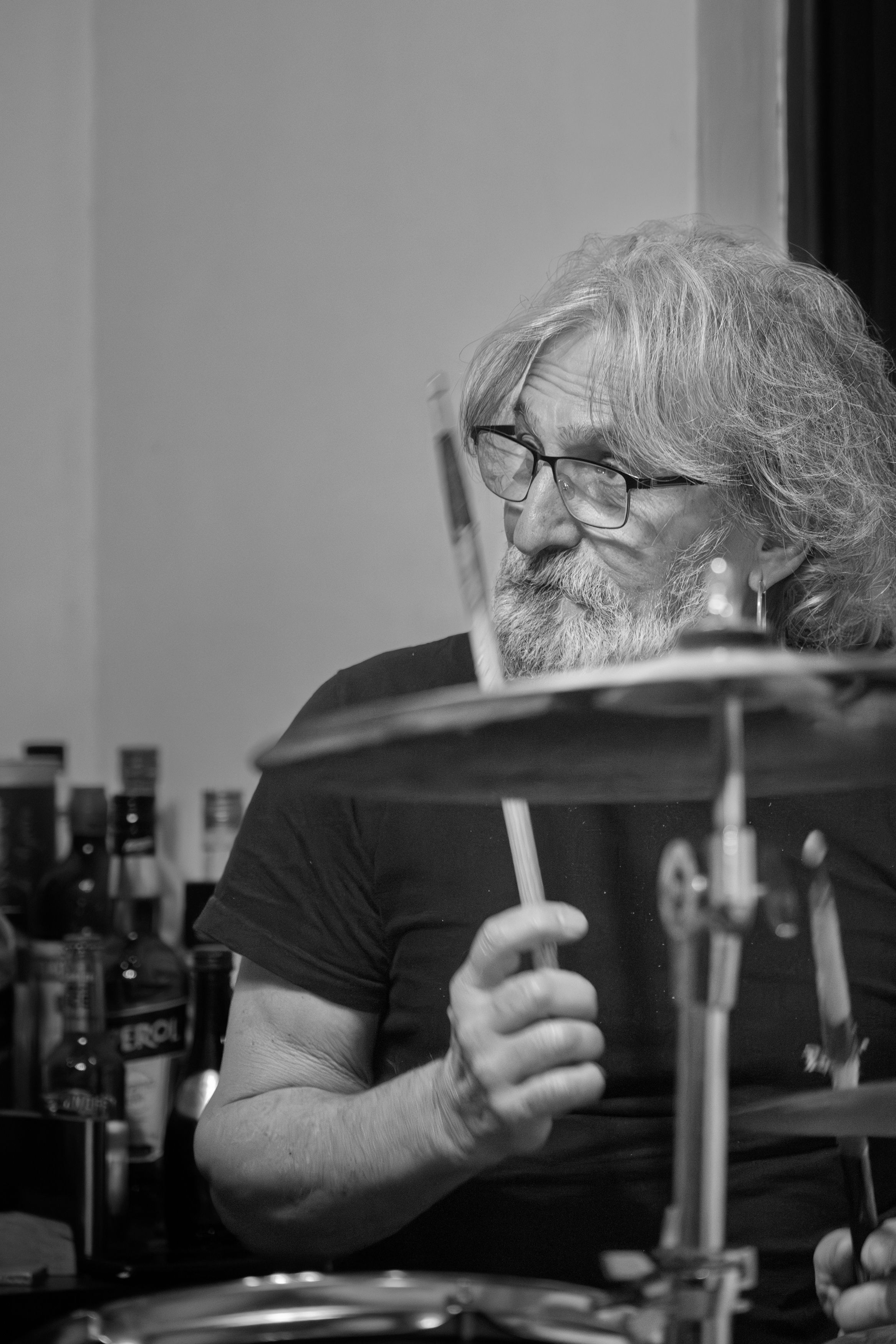 Elderly Drummer Performing Indoors in Black and White · Free Stock Photo