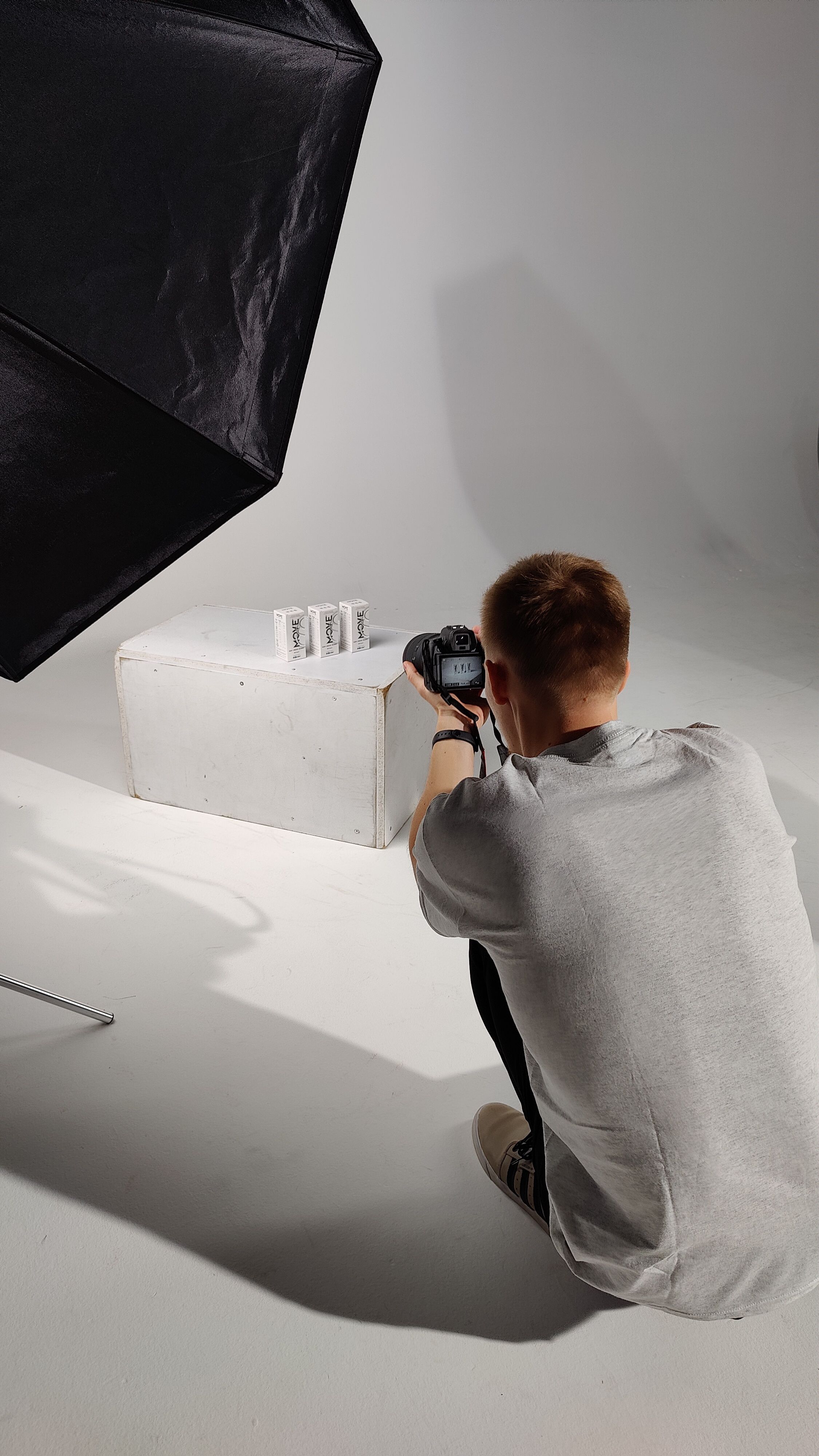 Photographer in Studio Capturing Product Shots · Free Stock Photo