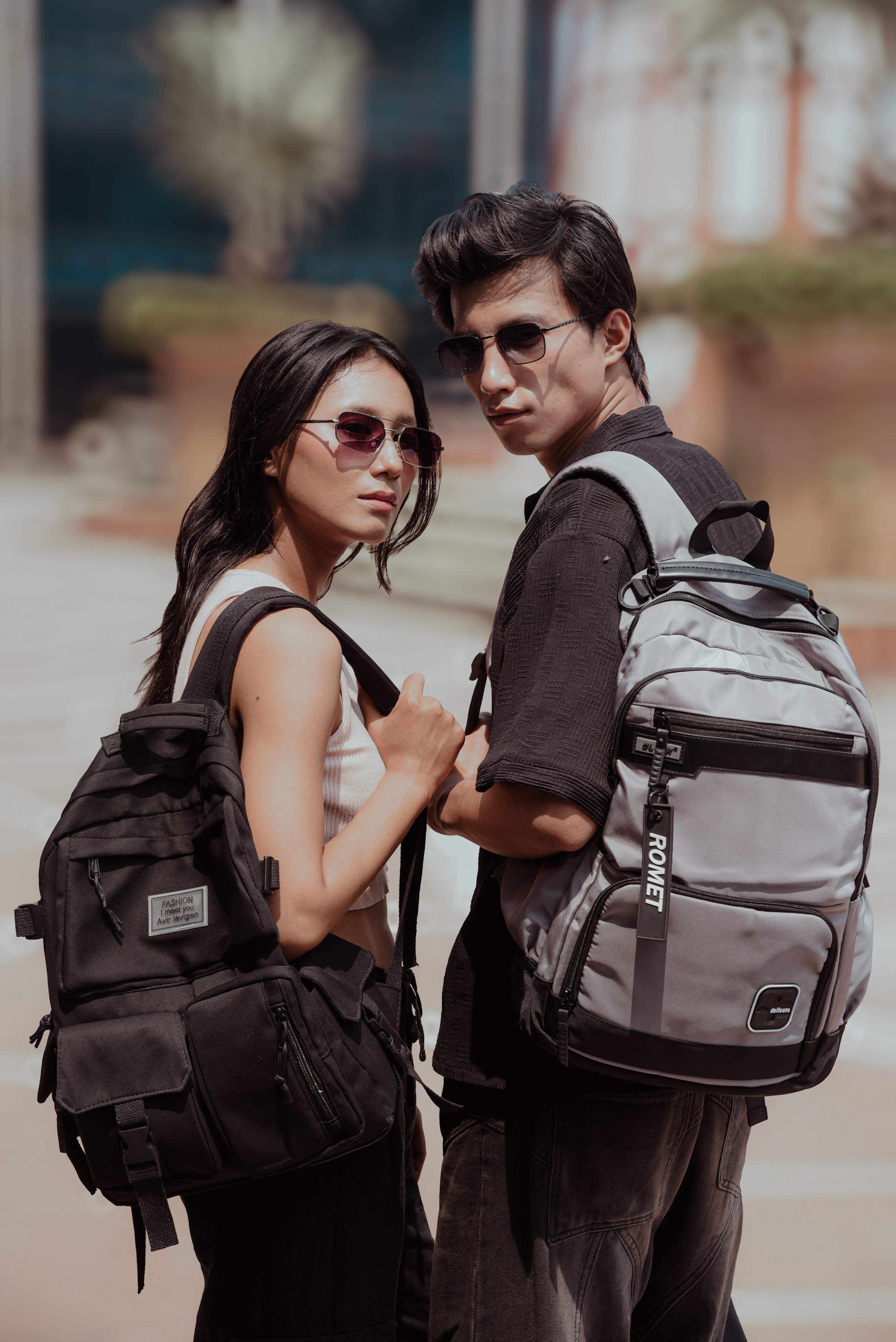 Stylish Young Couple with Backpacks Outdoors · Free Stock Photo