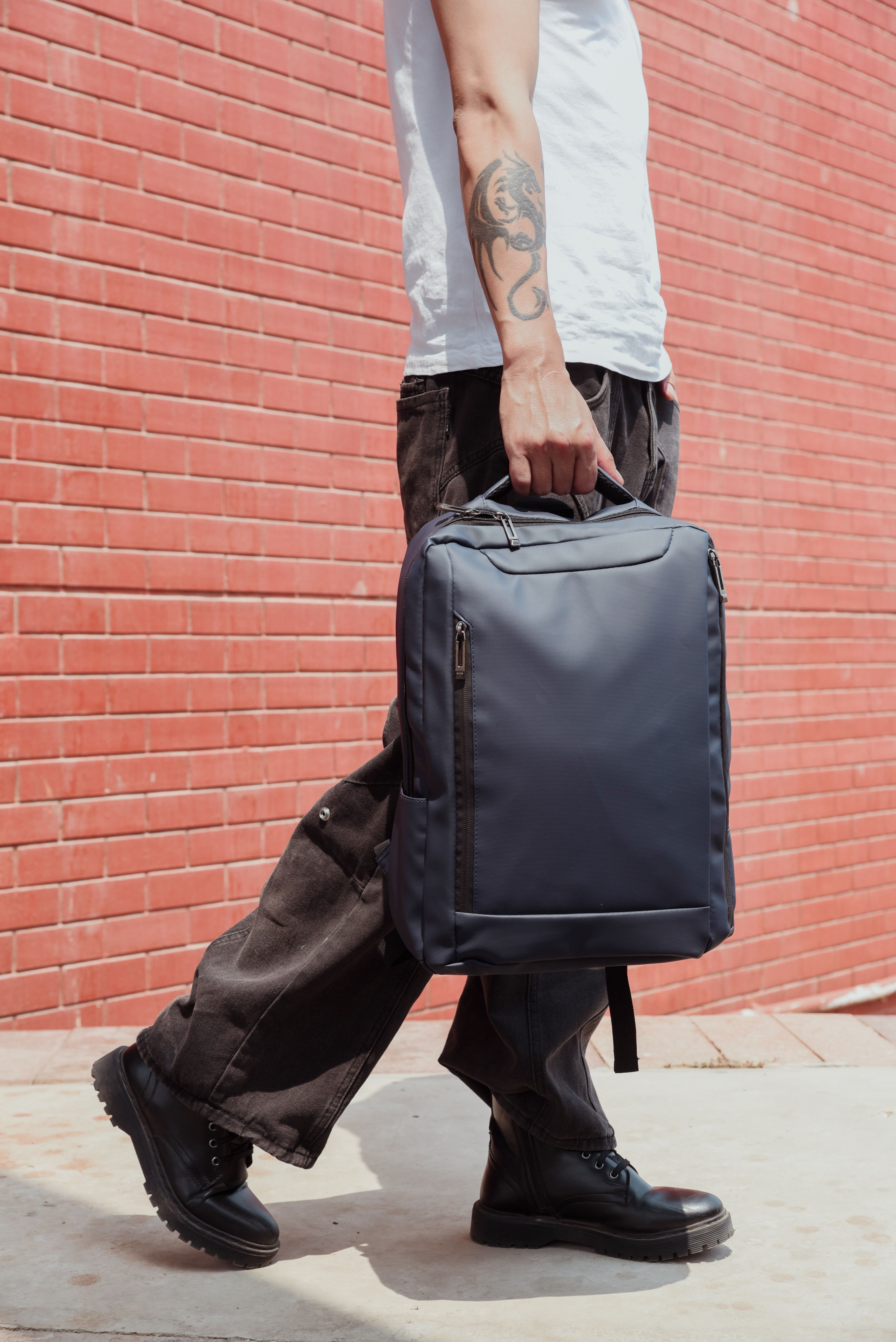 Woman Carrying Brown Leather Backpack Posing in Front of Roll-up Door ...
