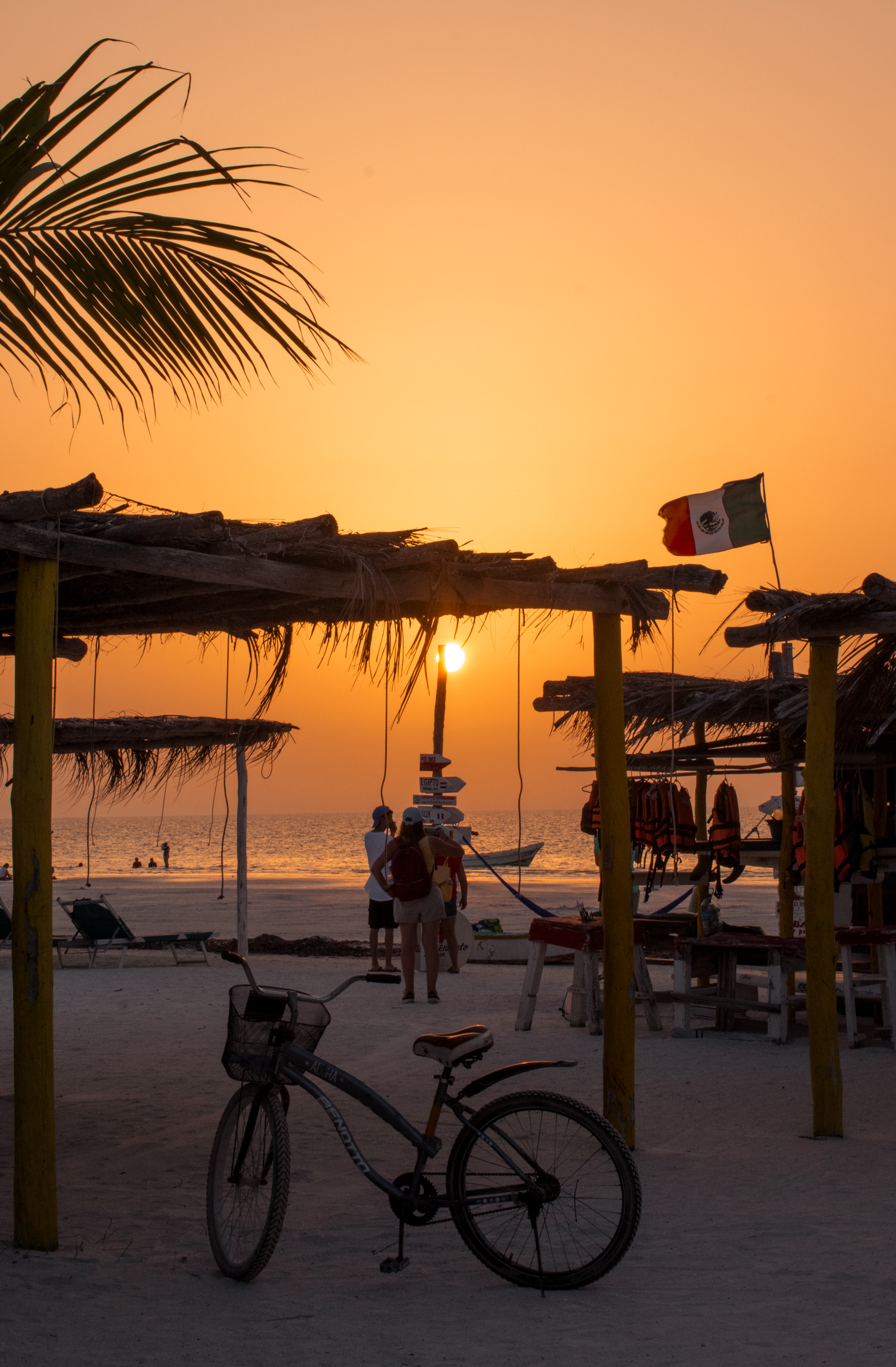 Sunset on a Mexican Beach with Bicycle and Flag · Free Stock Photo