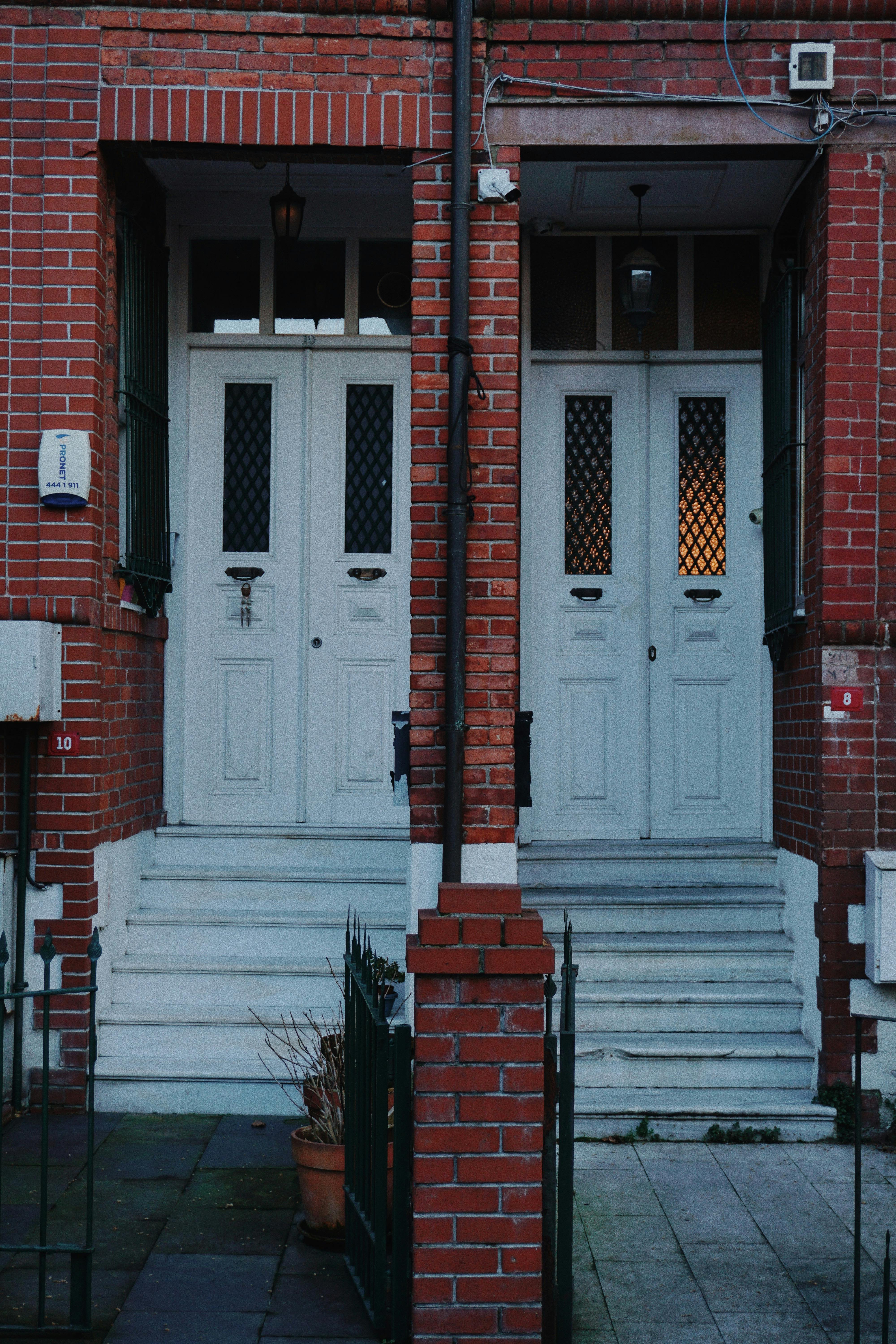 Classic Red Brick Duplex with White Doors · Free Stock Photo