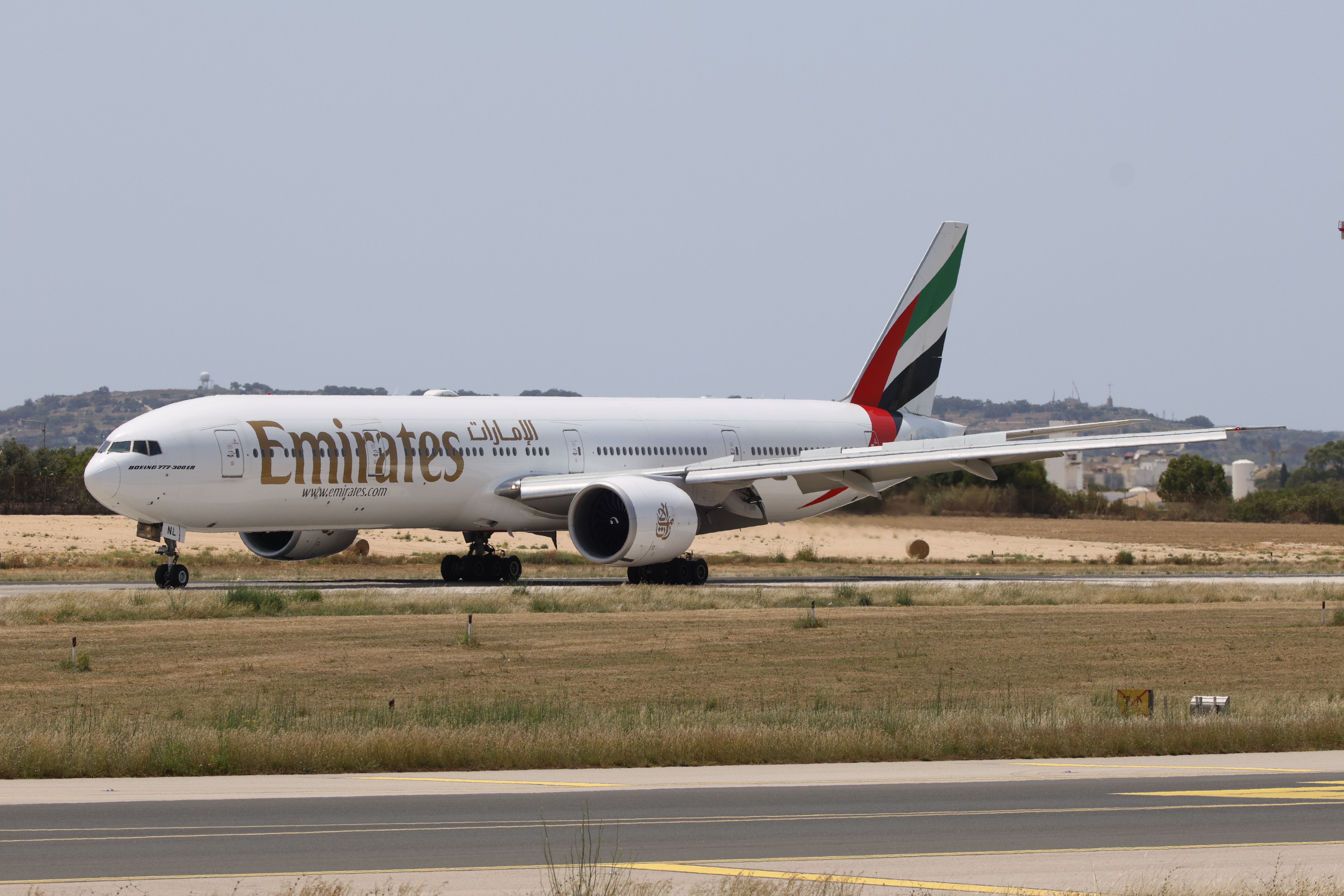 Emirates Boeing 777 on Airport Runway · Free Stock Photo