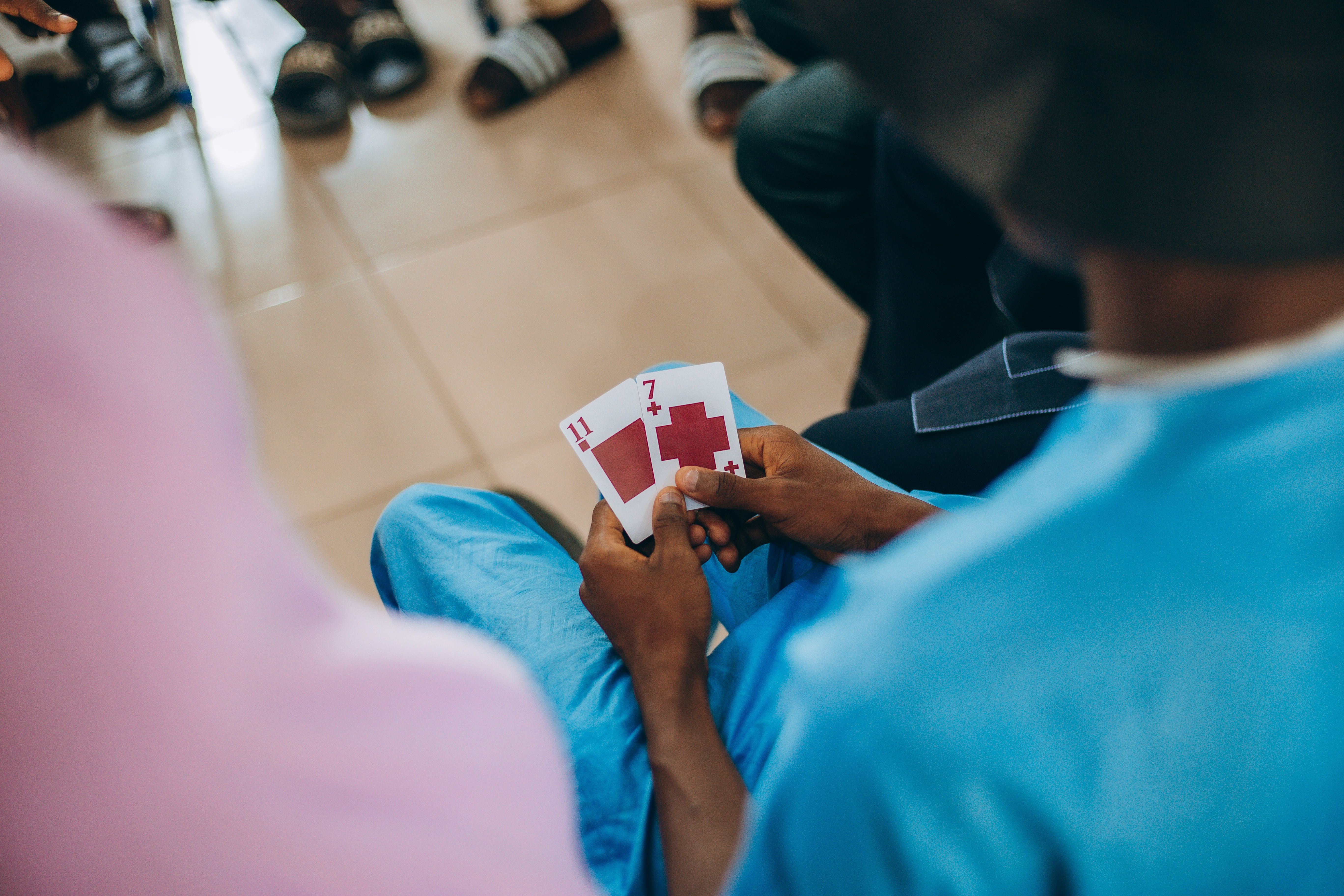 Close-up of a Man Playing Cards Indoors · Free Stock Photo