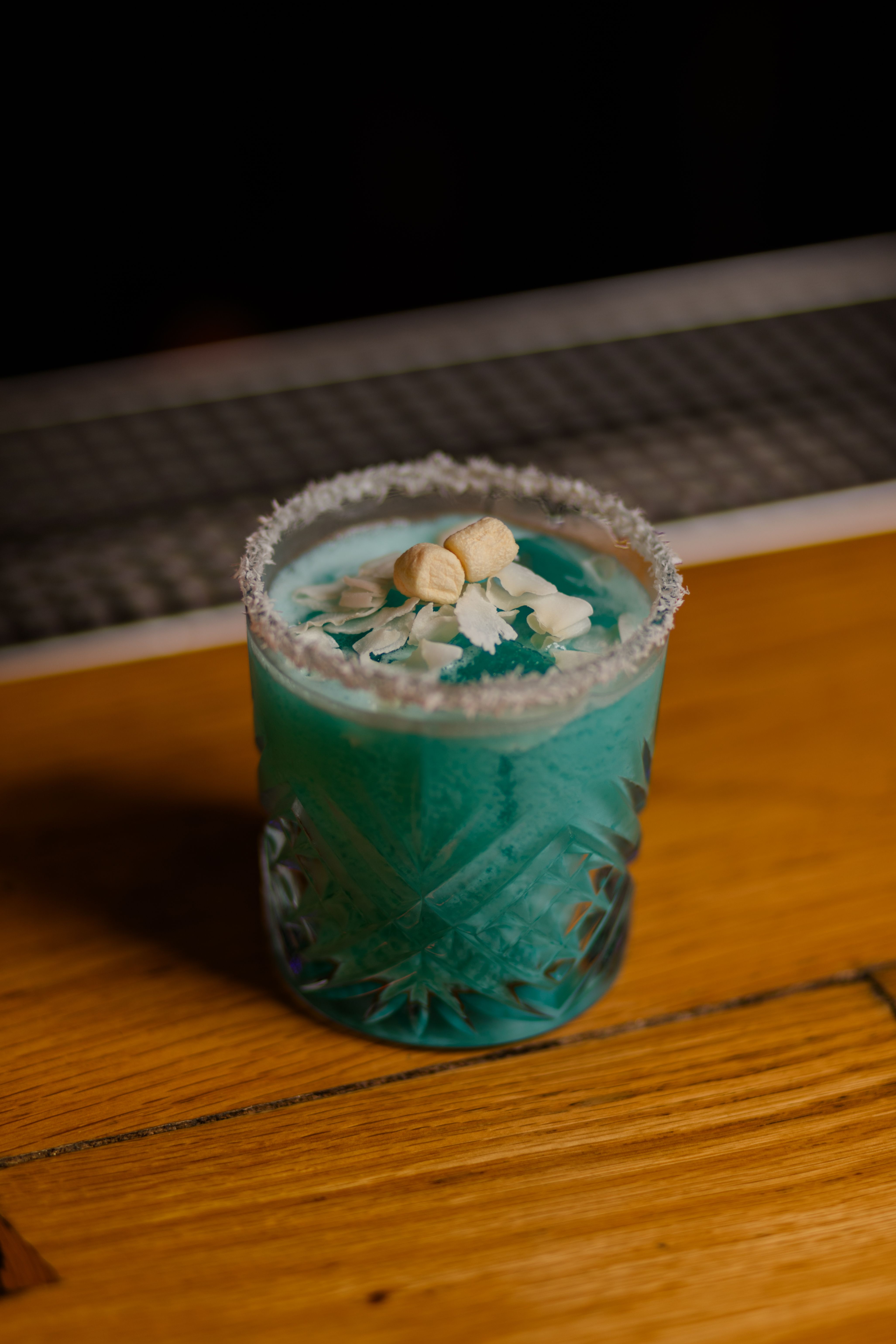 Blue Cocktail with Floral Garnish in a Crystal Glass · Free Stock Photo