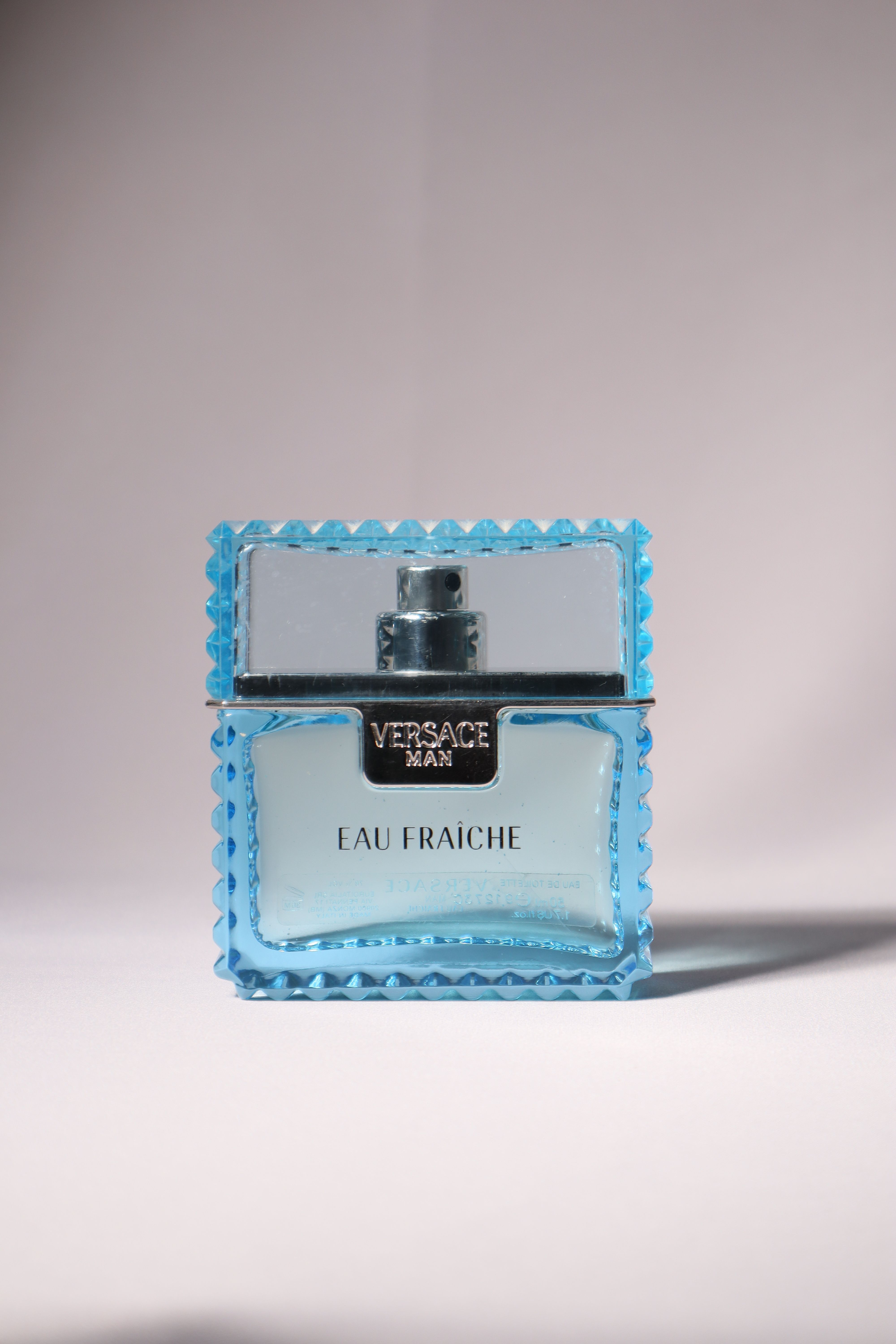 Versace Eau Fraîche Perfume Bottle on Light Background · Free Stock Photo