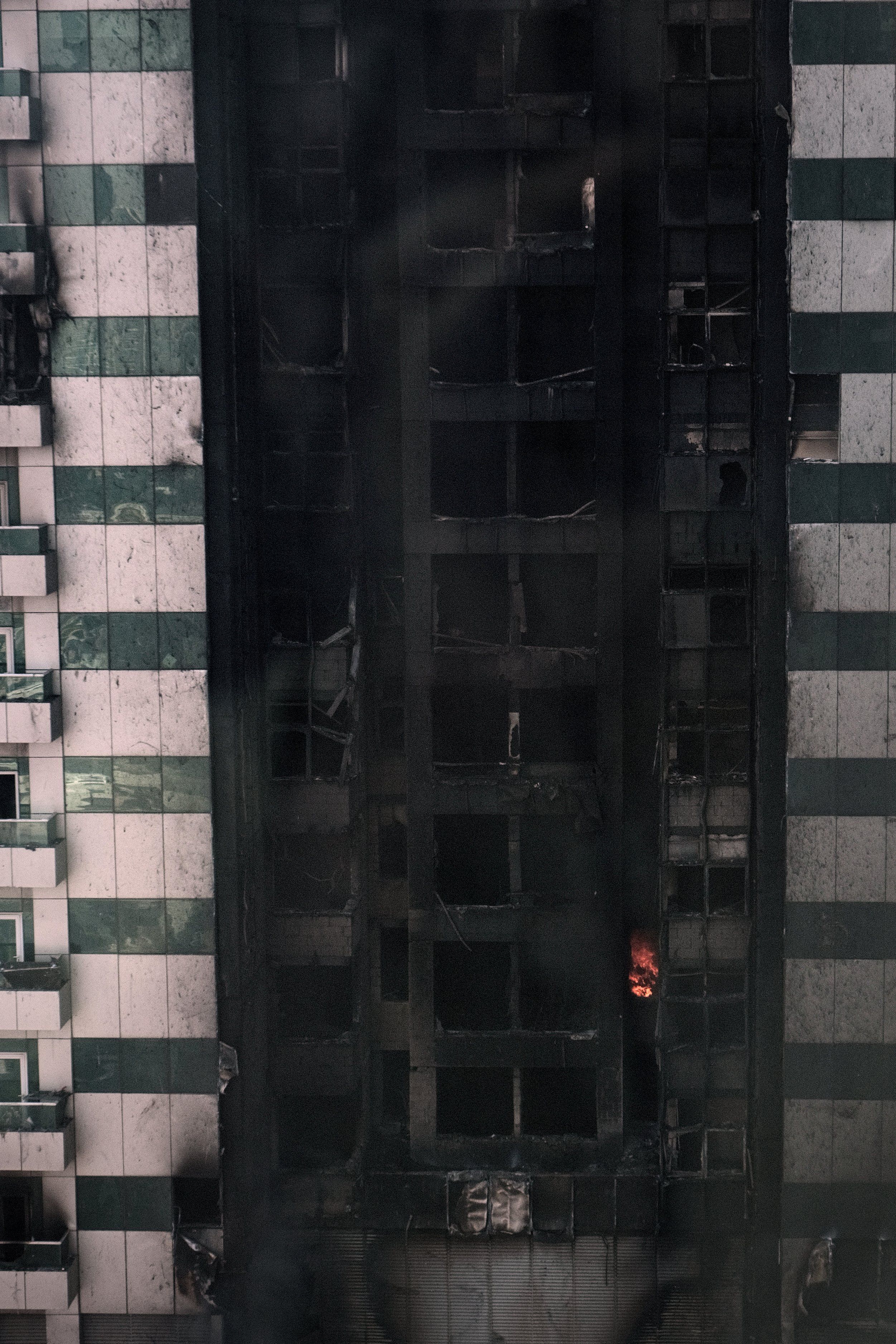 Skyscraper Fire Aftermath with Blackened Facade · Free Stock Photo