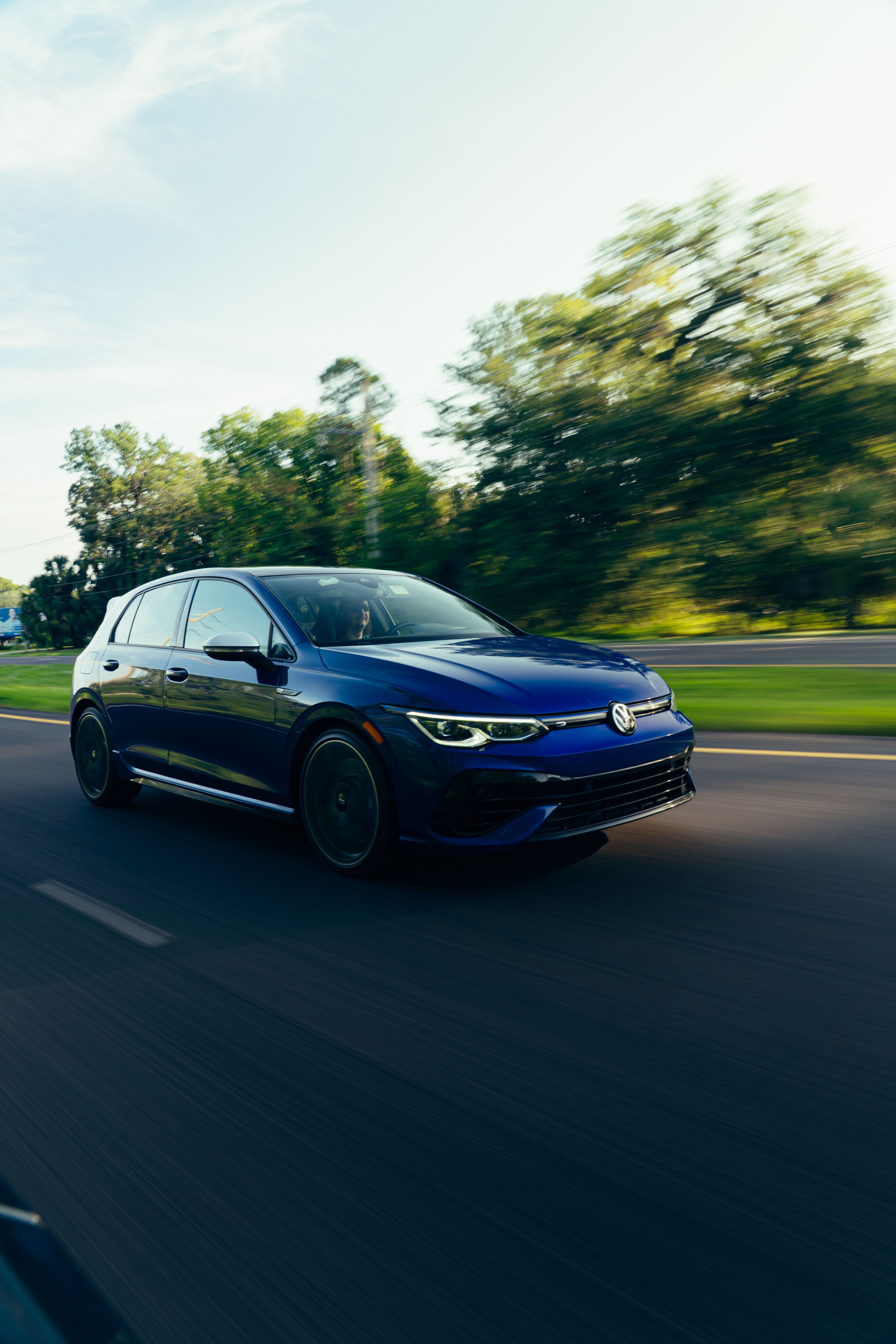 Dynamic Blue Car on Scenic Highway Drive · Free Stock Photo