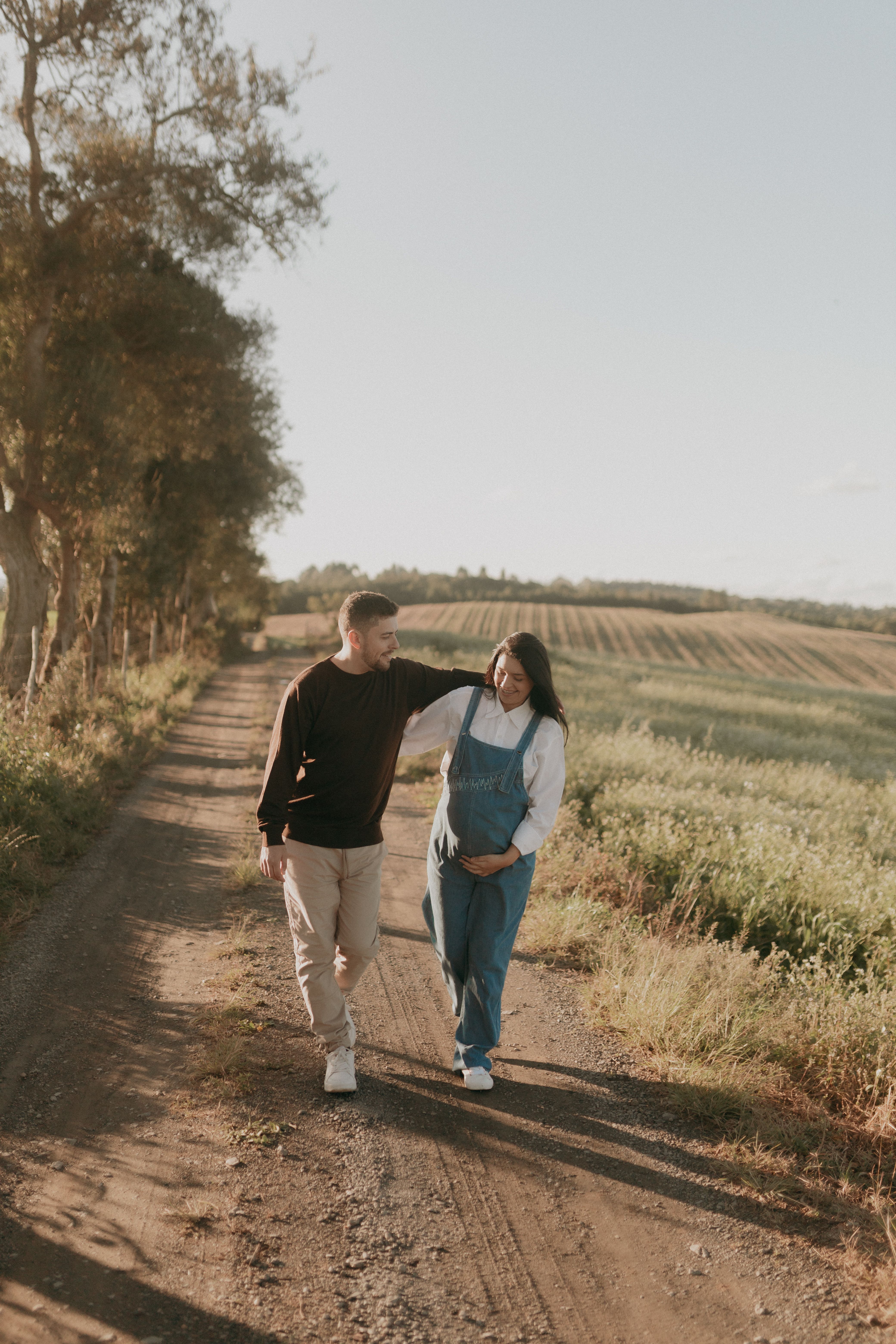 Couple Walking on Scenic Farm Pathway at Sunset · Free Stock Photo