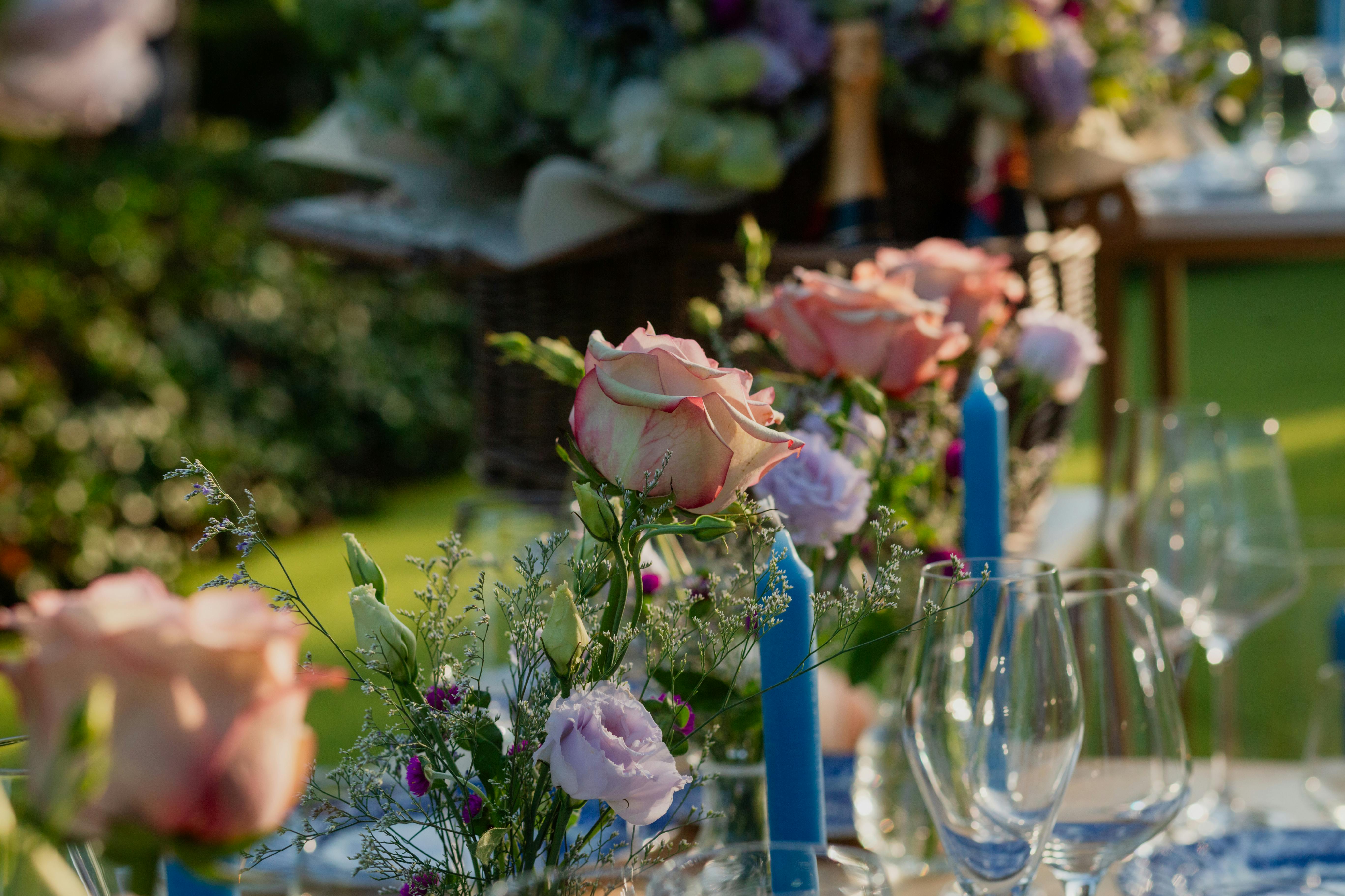 Romantic Outdoor Table Setting with Flowers and Candles · Free Stock Photo