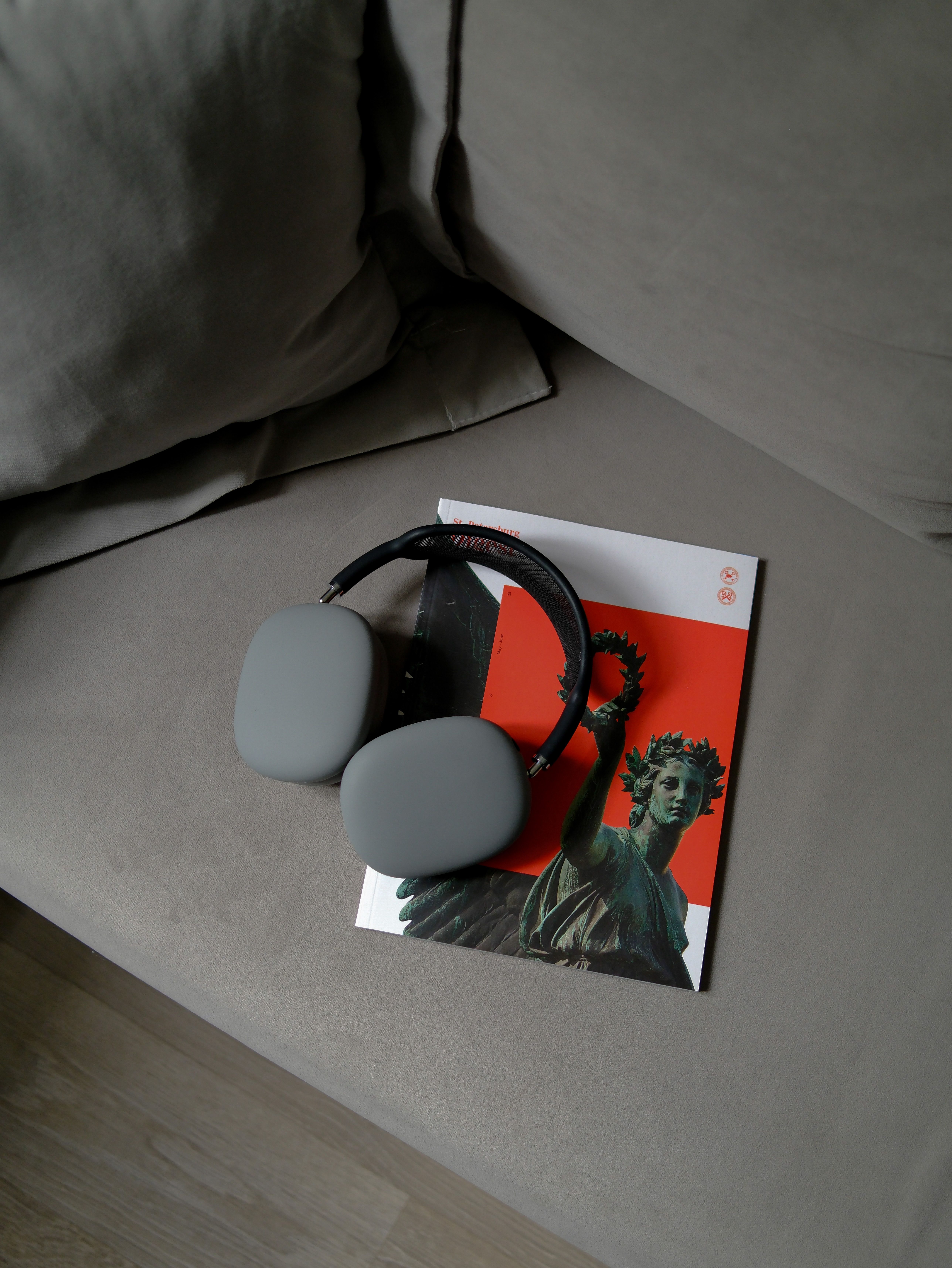 Modern Headphones on Magazine Cover Featuring Statue · Free Stock Photo