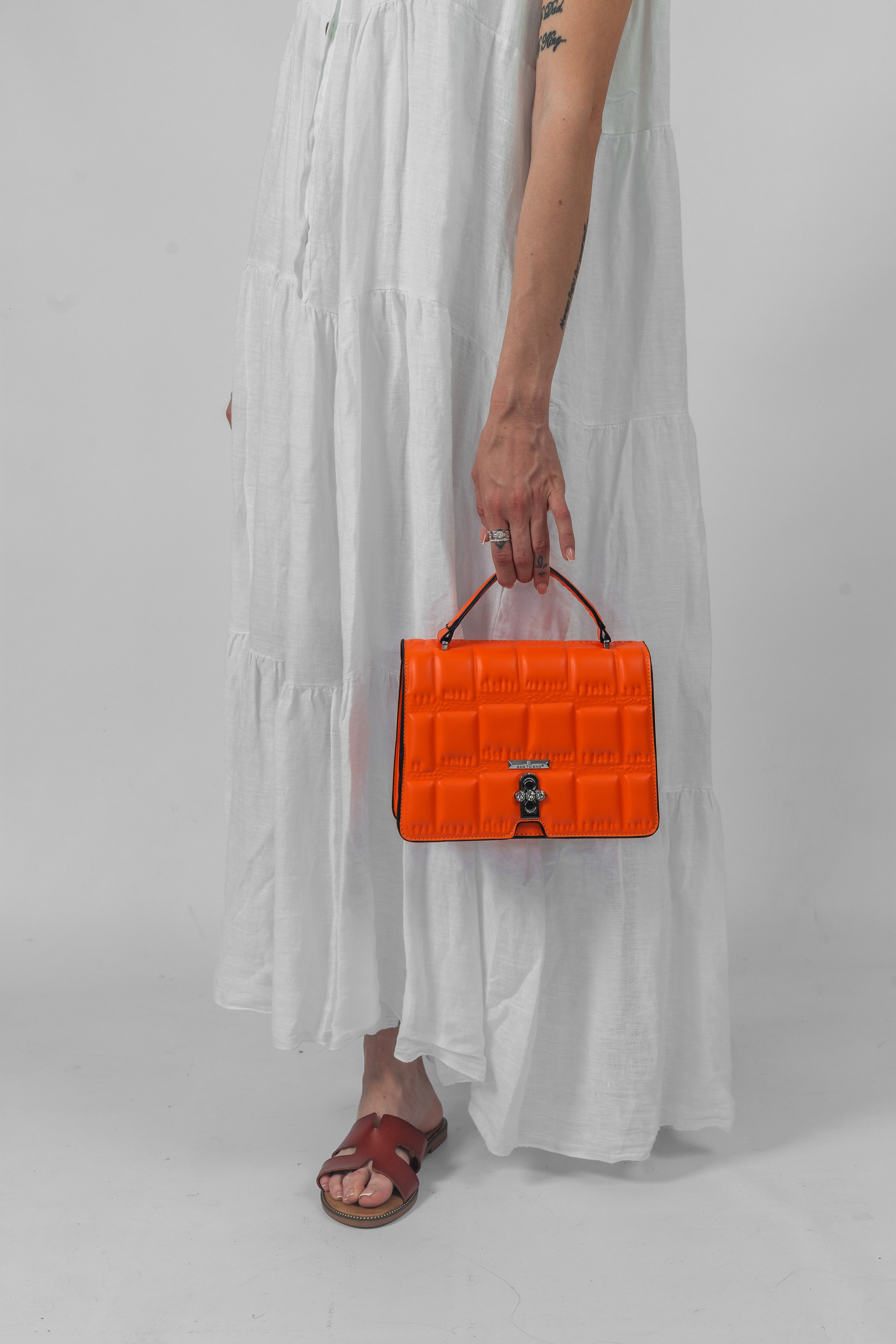 Elegant White Dress with Vibrant Orange Handbag · Free Stock Photo