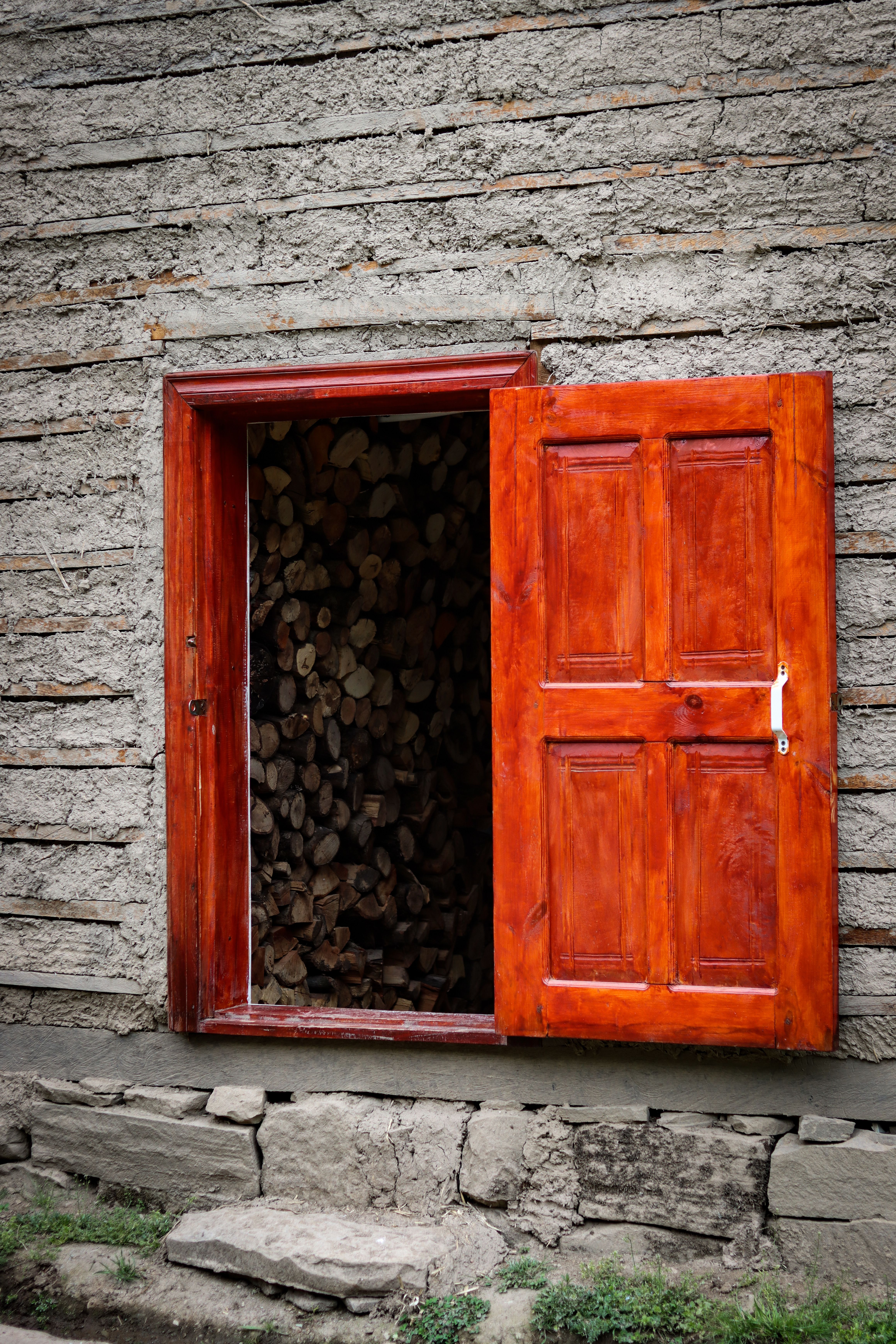 Rustic Wooden Door Leading to Log Pile Storage · Free Stock Photo