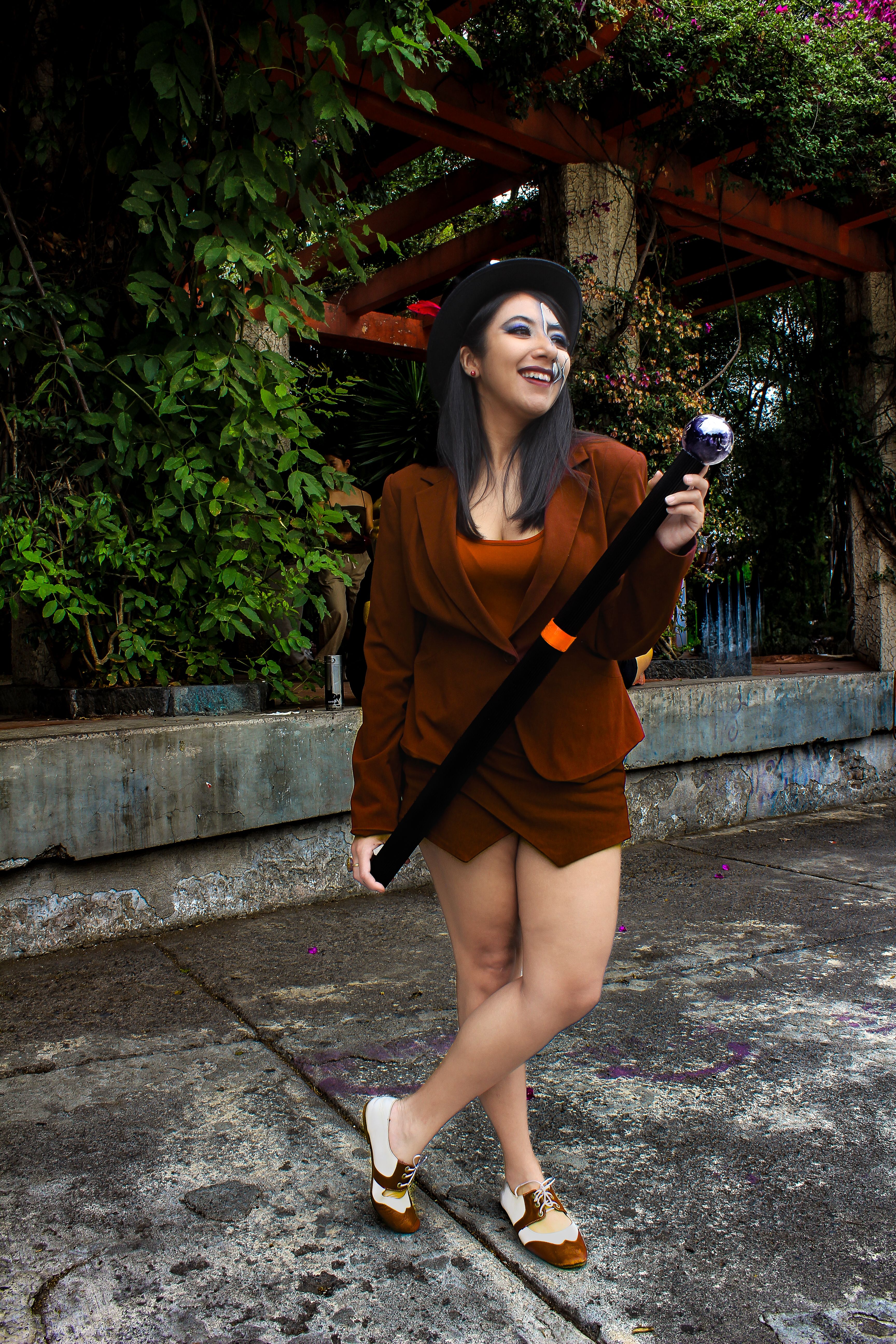 Stylish Woman in Brown Suit with Cane Outdoors · Free Stock Photo