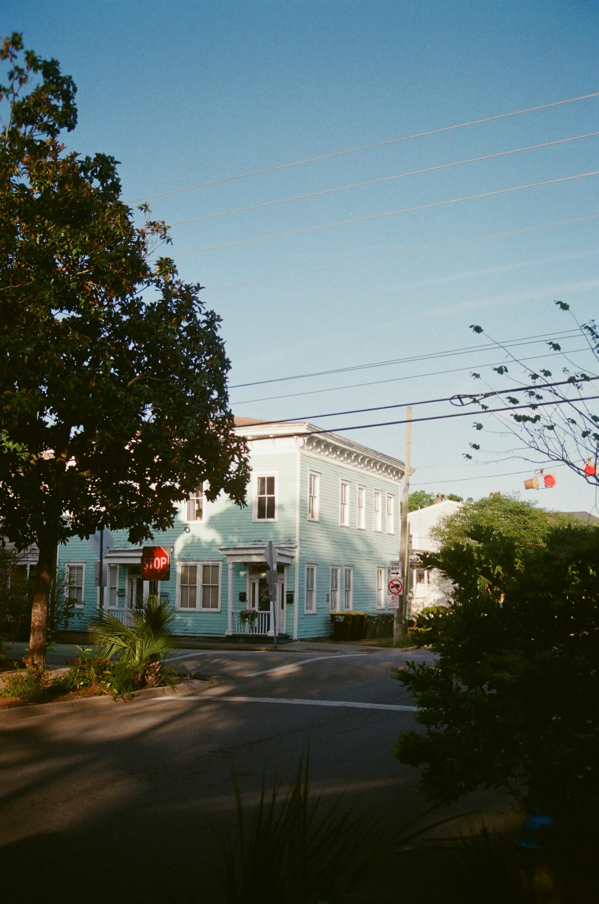 Charming Blue House on Sunny Street Corner · Free Stock Photo
