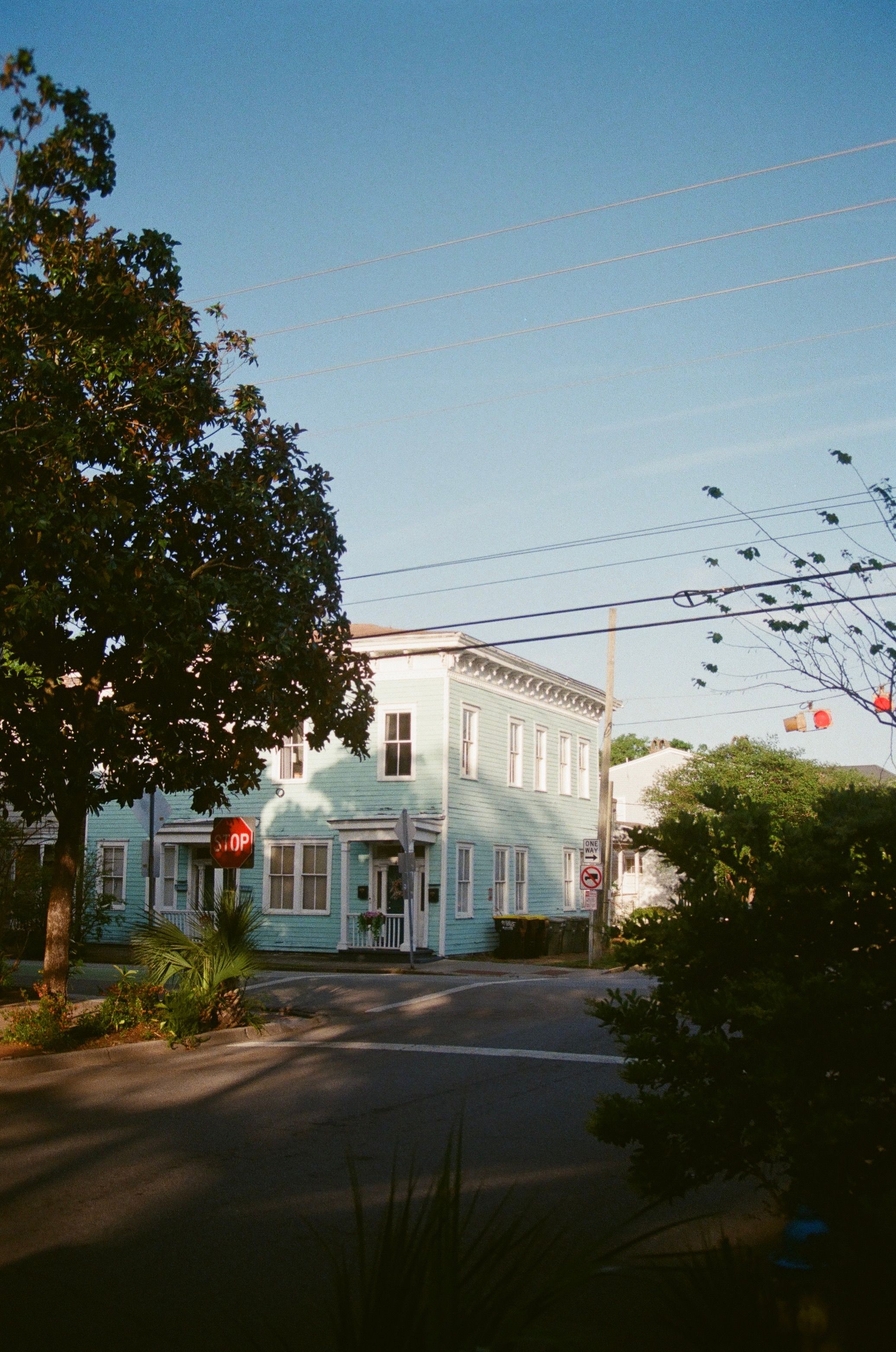Charming Blue House on Sunny Street Corner · Free Stock Photo