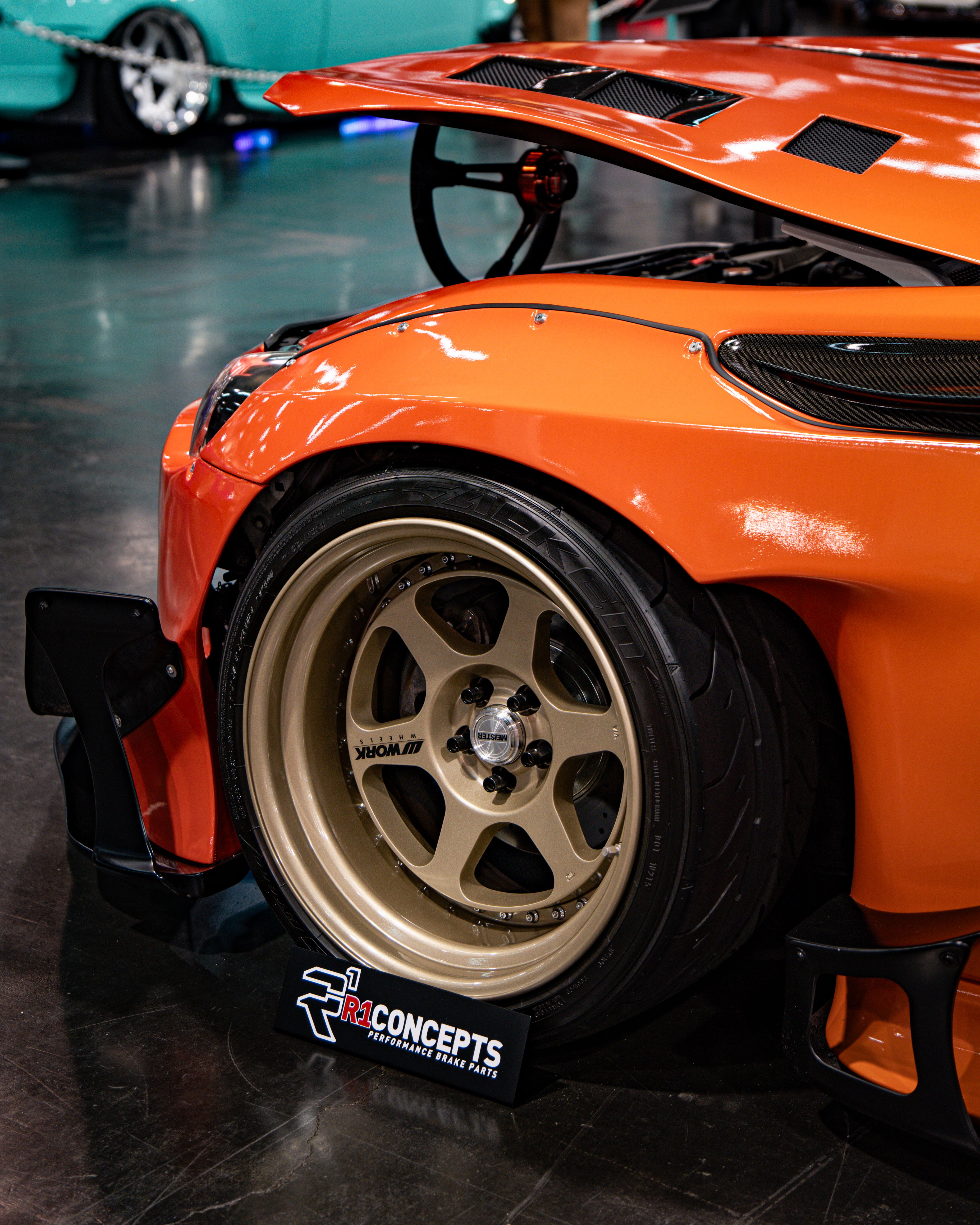 Close-up of Modified Orange Car at Auto Show · Free Stock Photo