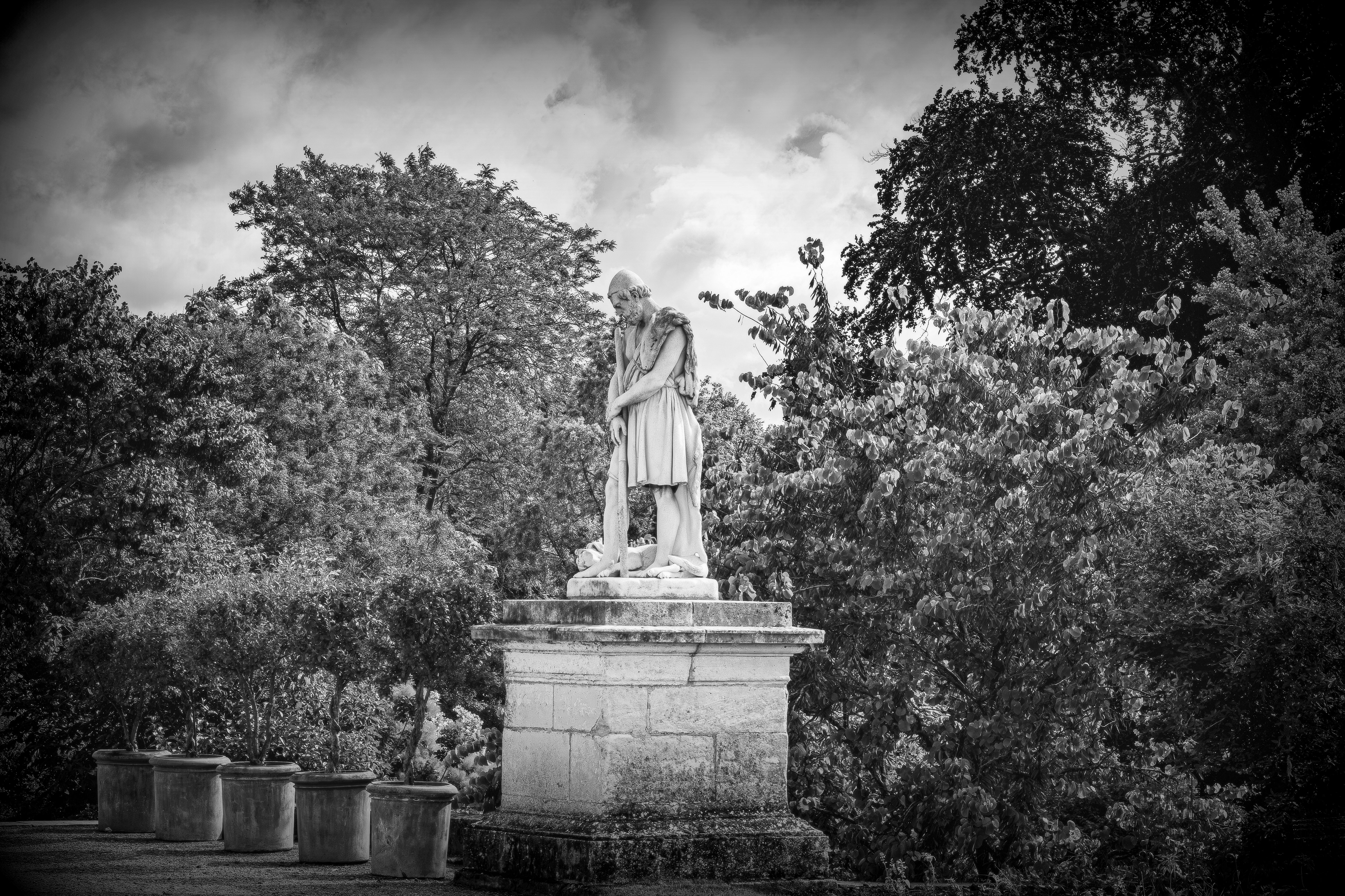 Classic Stone Statue in Lush Park Setting · Free Stock Photo