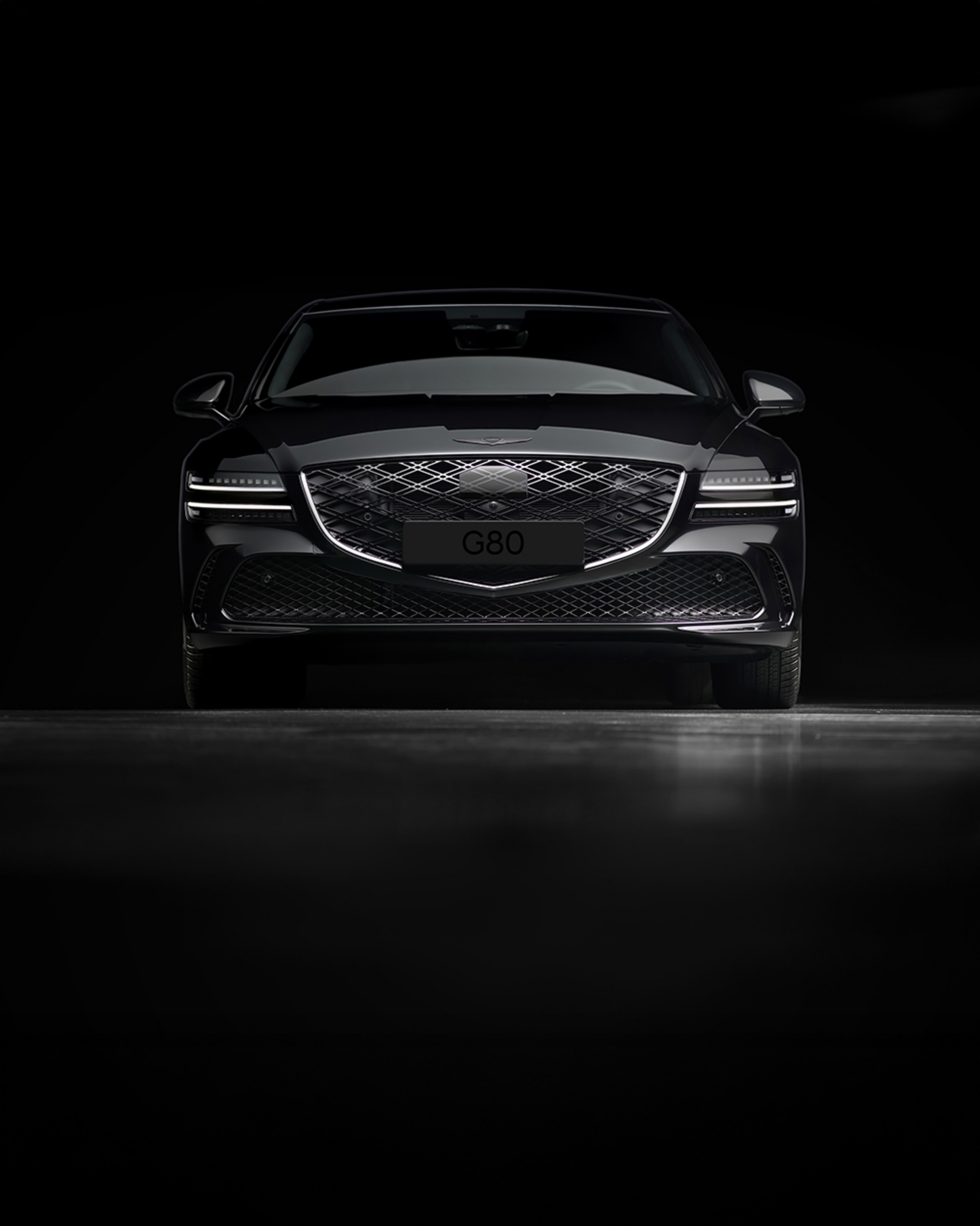 Sleek Genesis G80 Sedan in Dark Studio Setting · Free Stock Photo