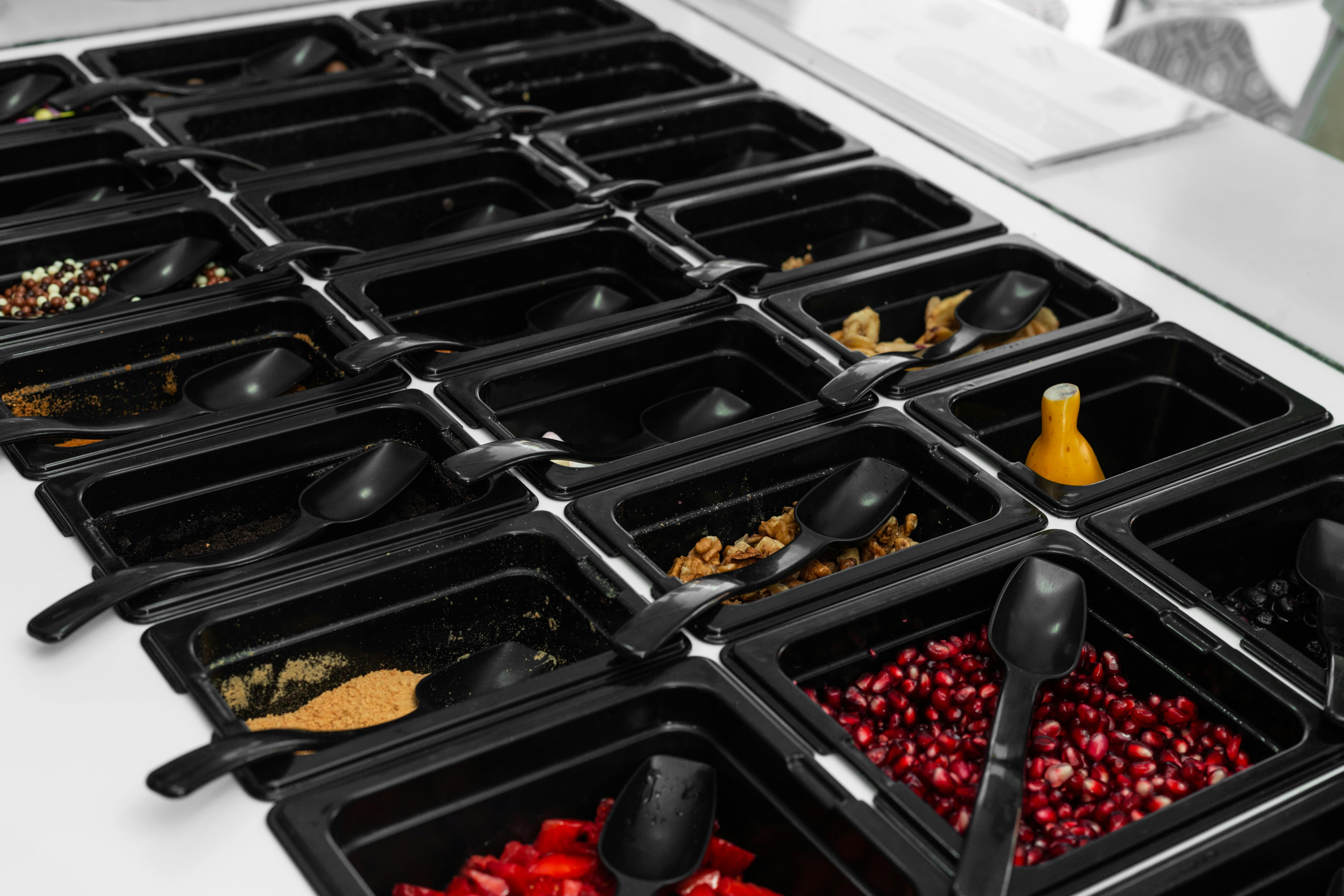 Assorted Toppings in Black Containers at Buffet · Free Stock Photo