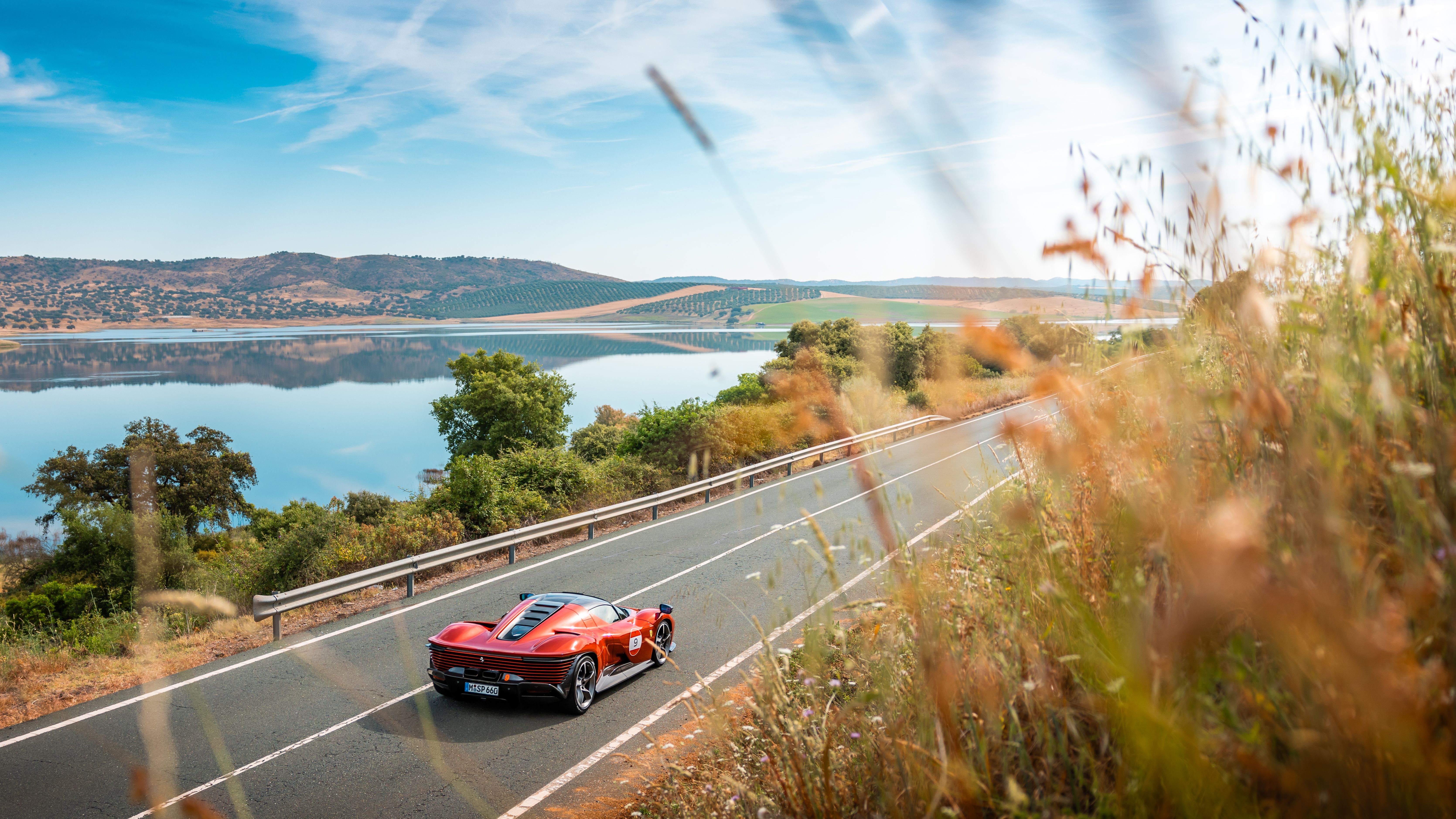 Exotic Sports Car Driving Along Scenic Lake Road · Free Stock Photo