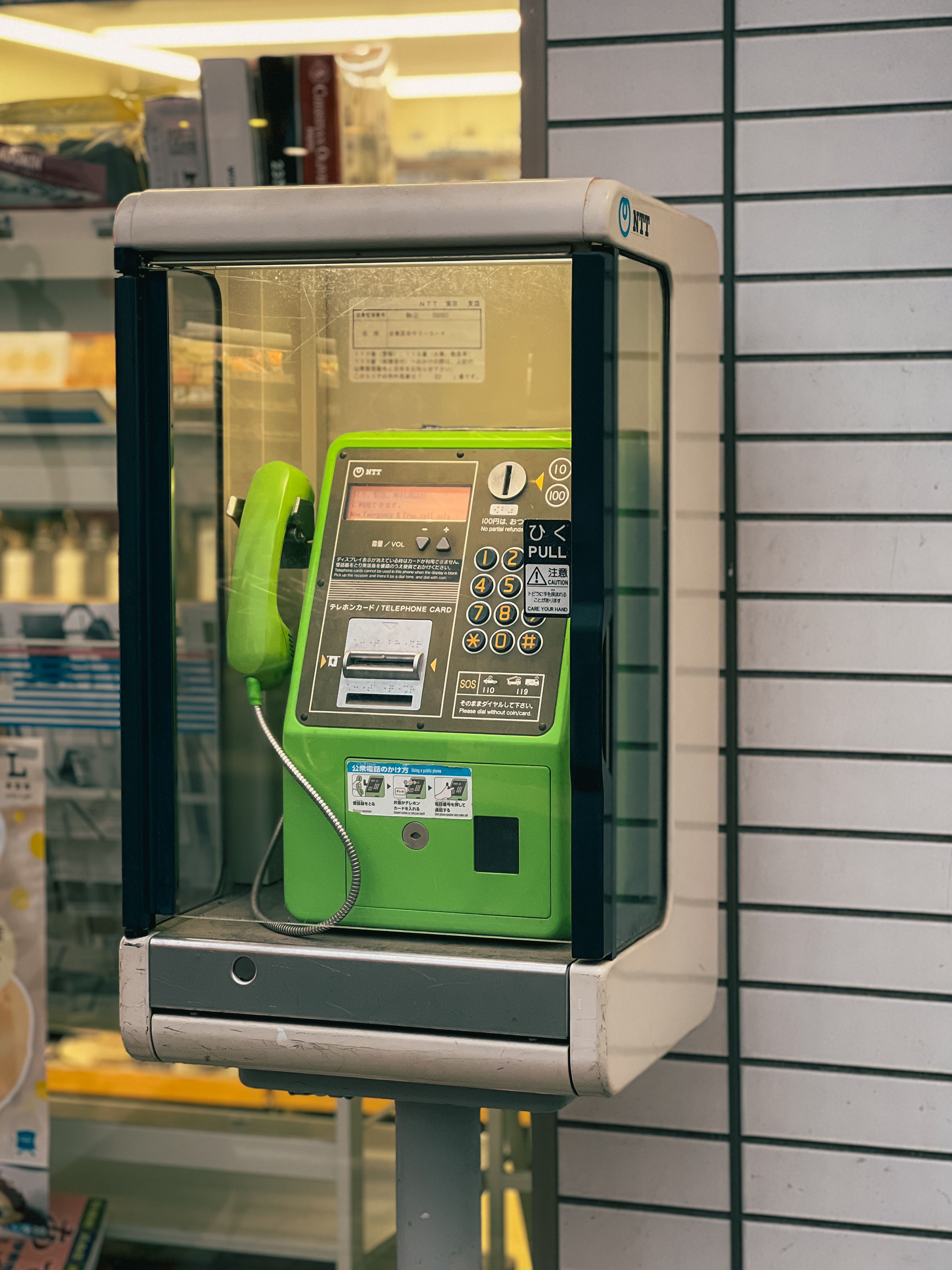 Retro Green Public Payphone in Urban Setting · Free Stock Photo