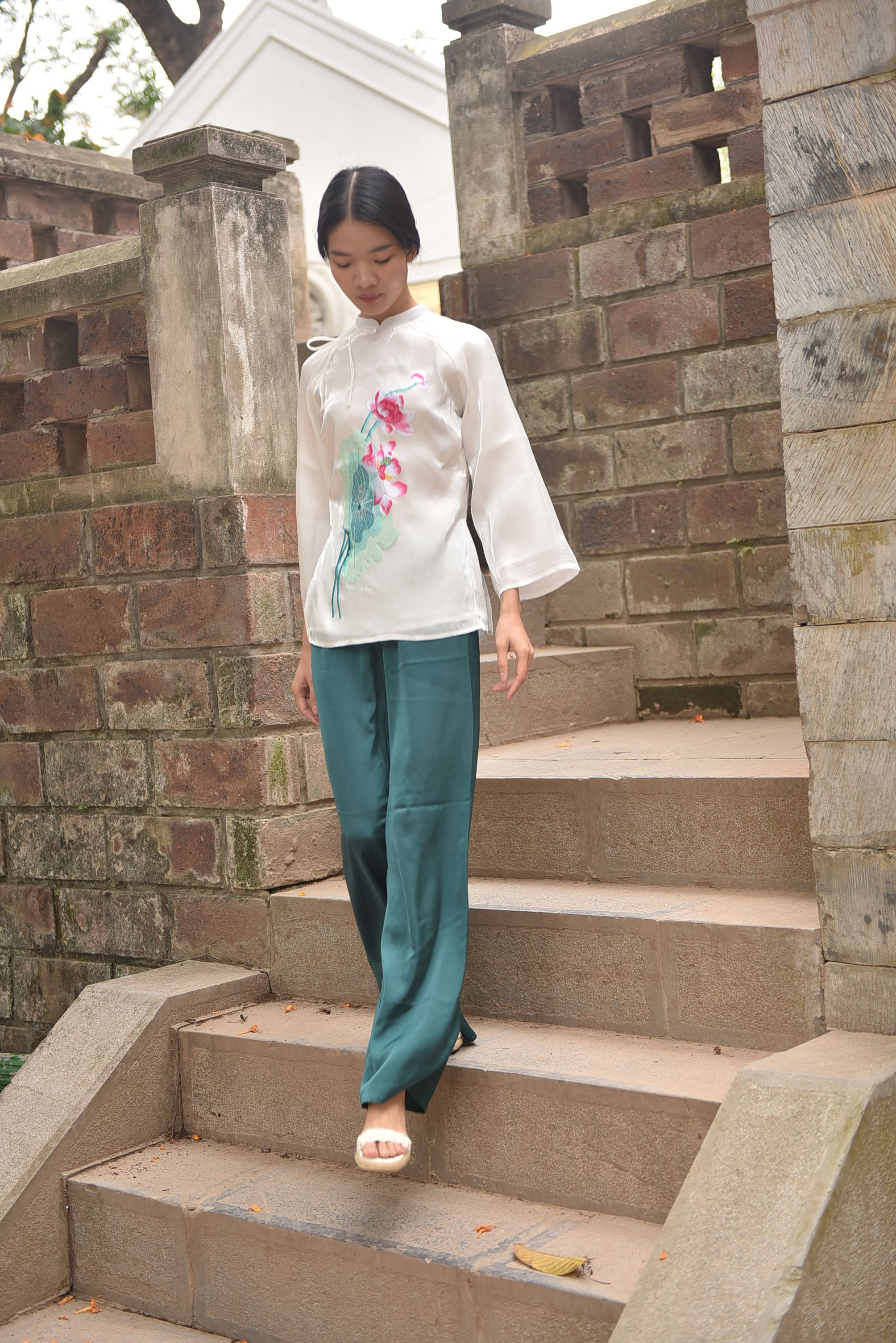 Elegant Woman Walking Down Historic Stone Stairs · Free Stock Photo