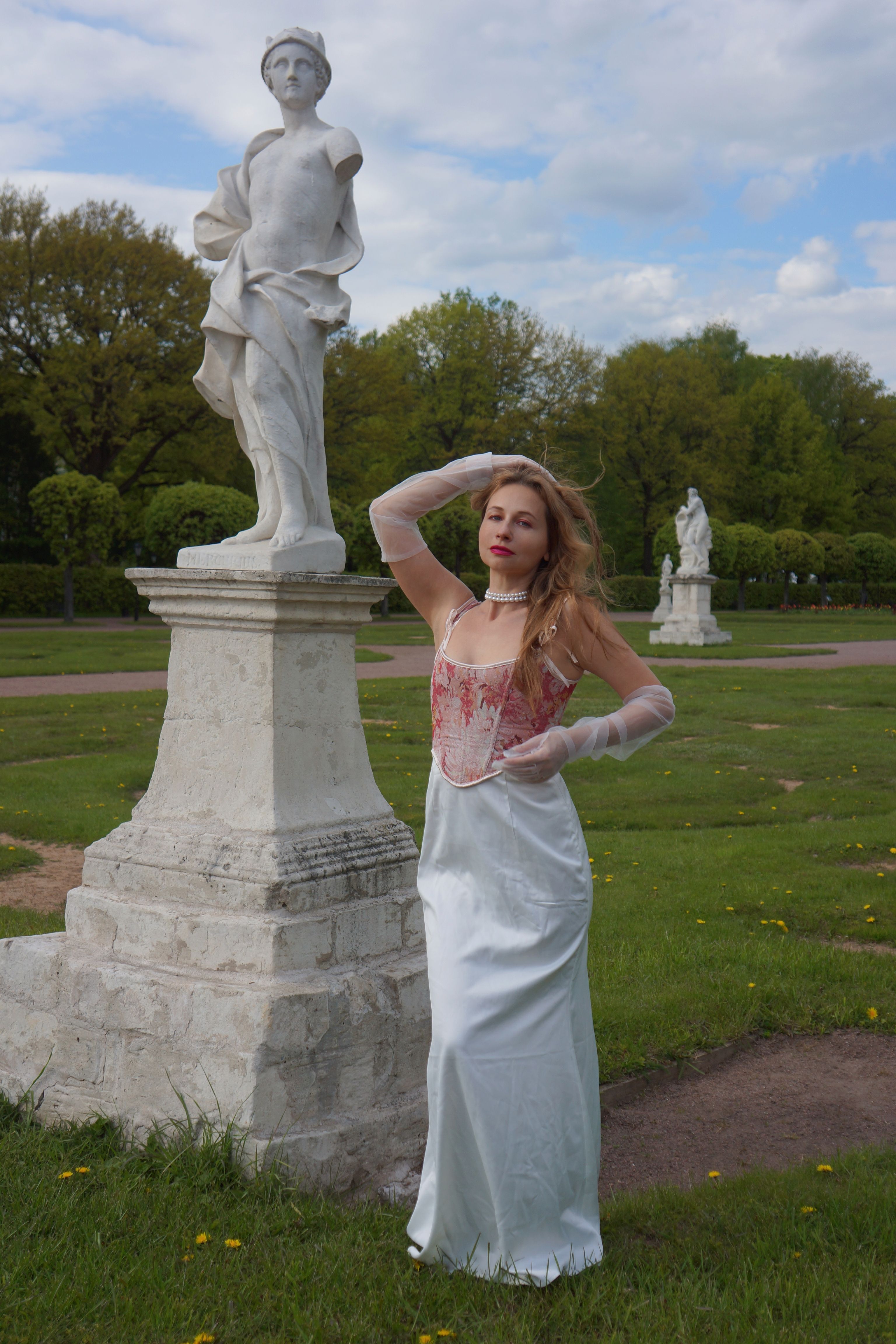 Woman in Elegant Dress Posing by Classic Statue · Free Stock Photo