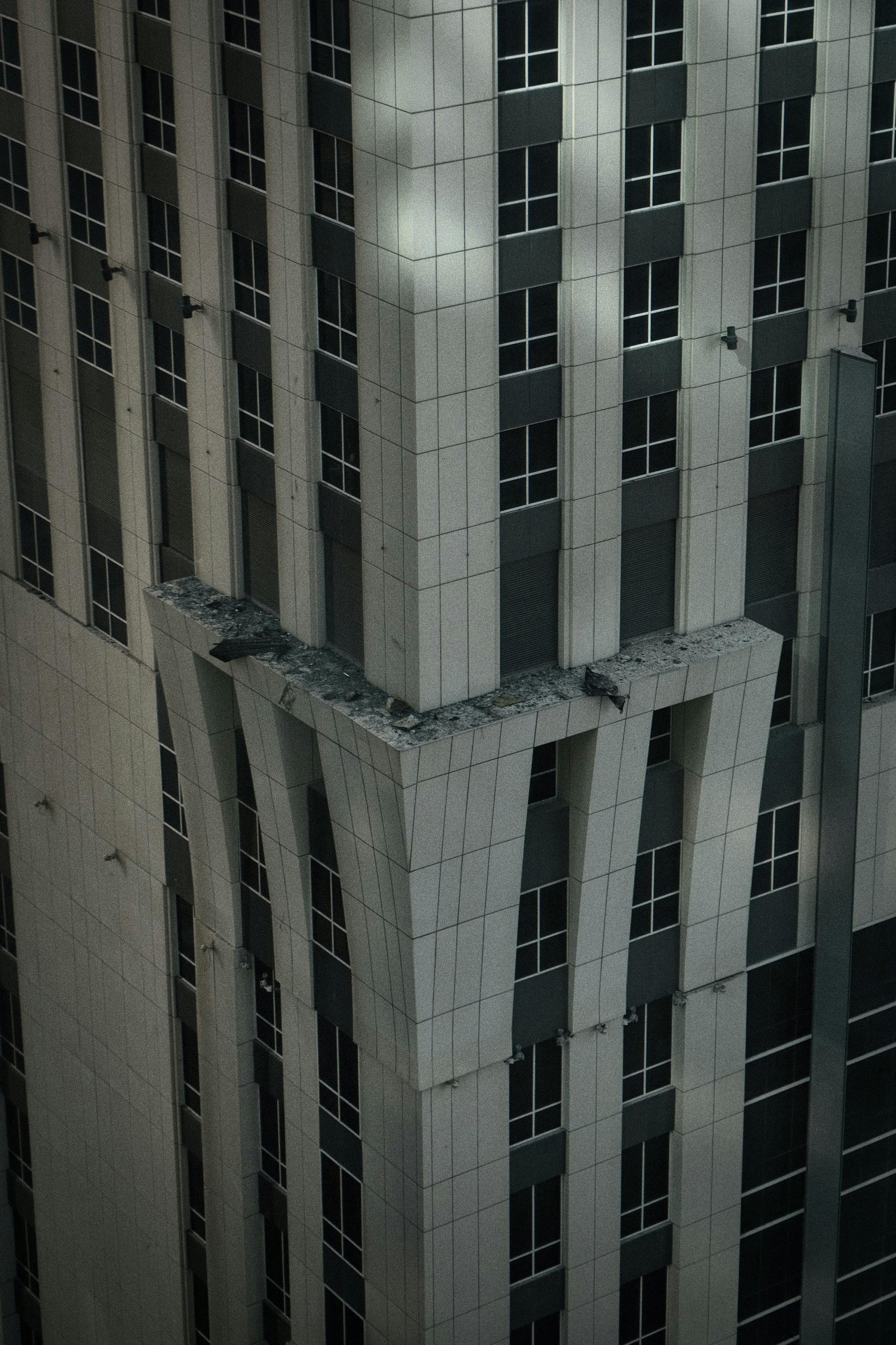 Damaged Skyscraper Facade Post-Disaster · Free Stock Photo