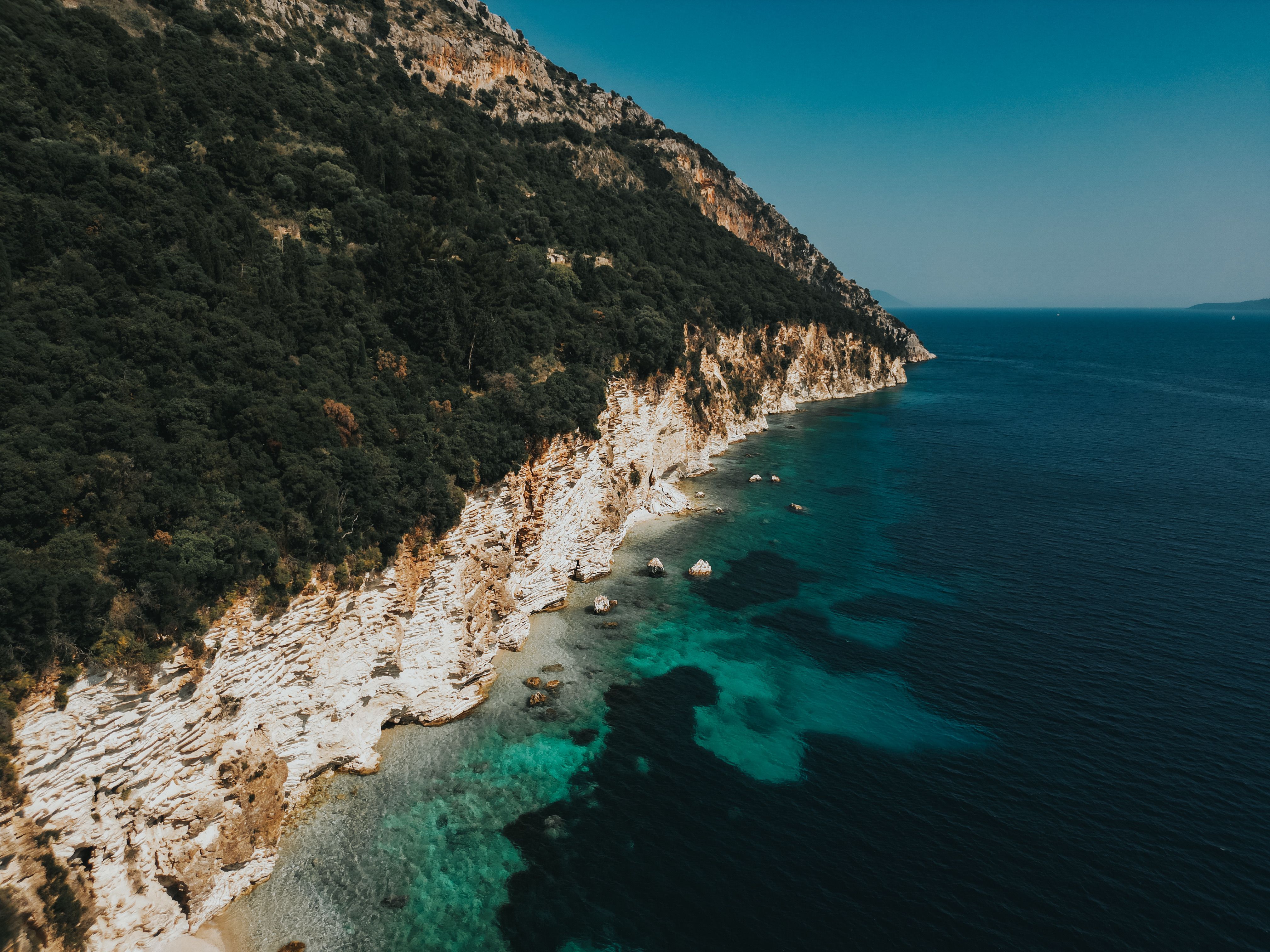 Scenic Aerial View of Coastal Cliff and Blue Sea · Free Stock Photo