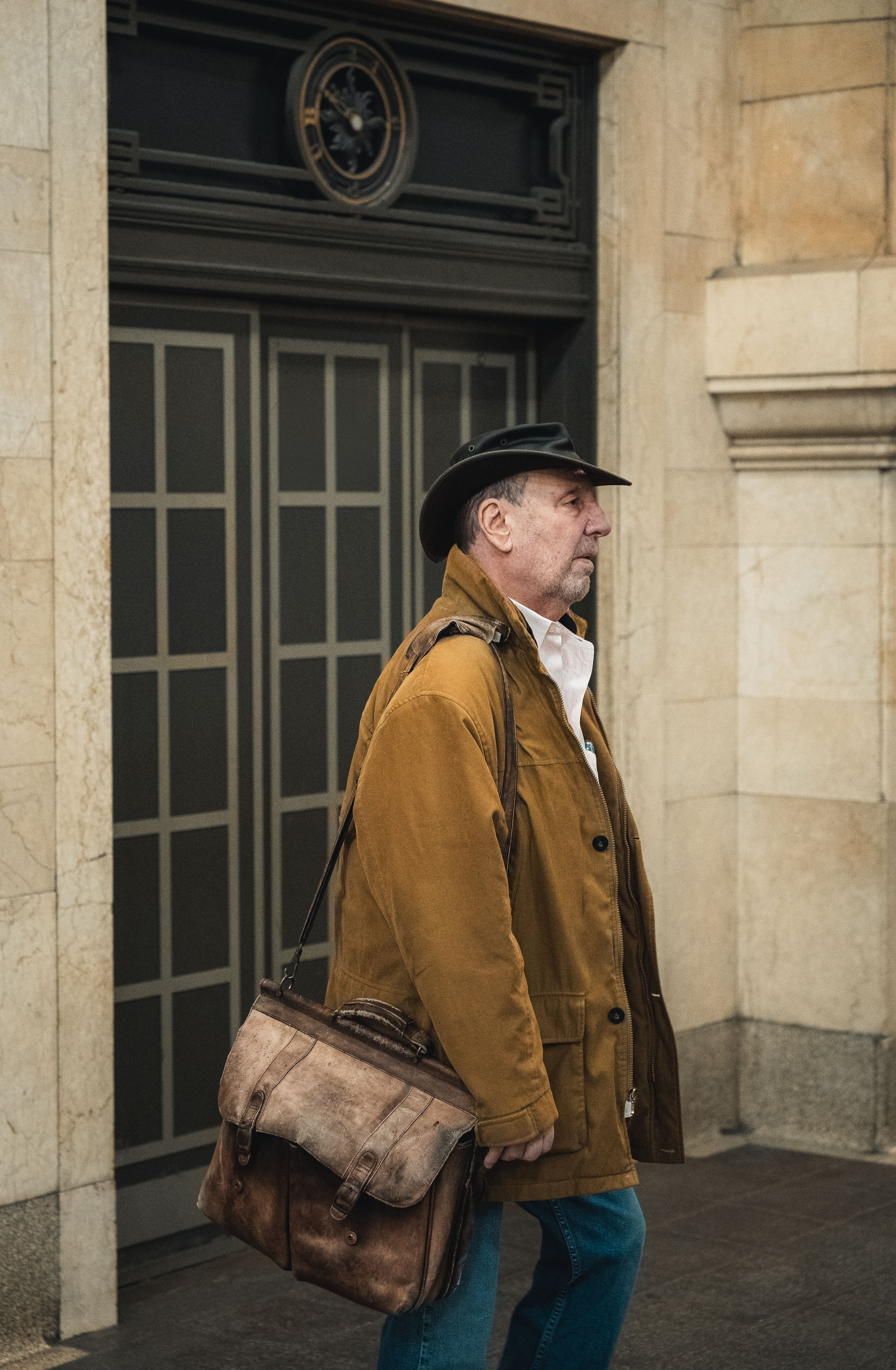 Man in Brown Jacket with Vintage Satchel Outdoors · Free Stock Photo