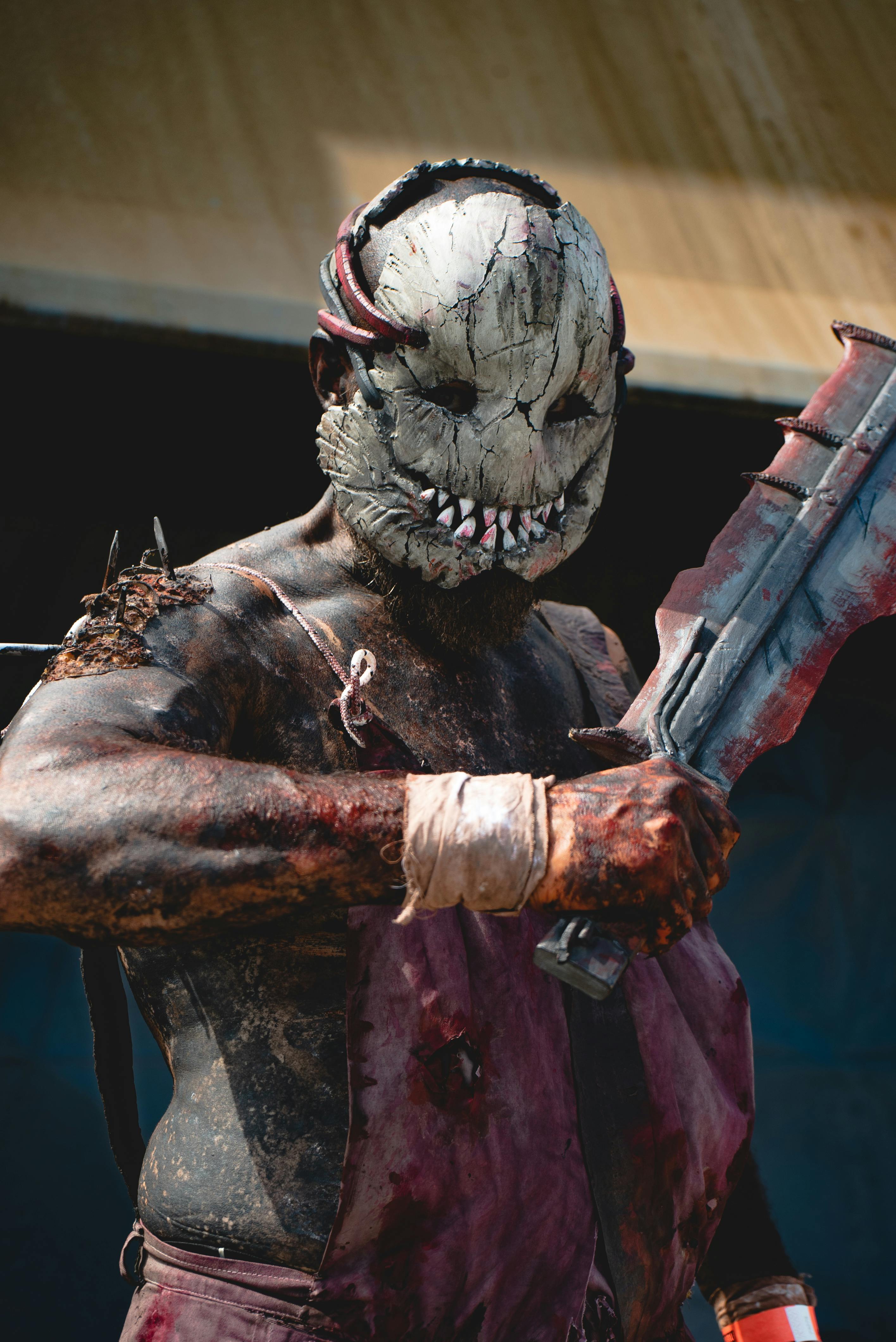 Intimidating Character in Horror Costume Holding Weapon · Free Stock Photo