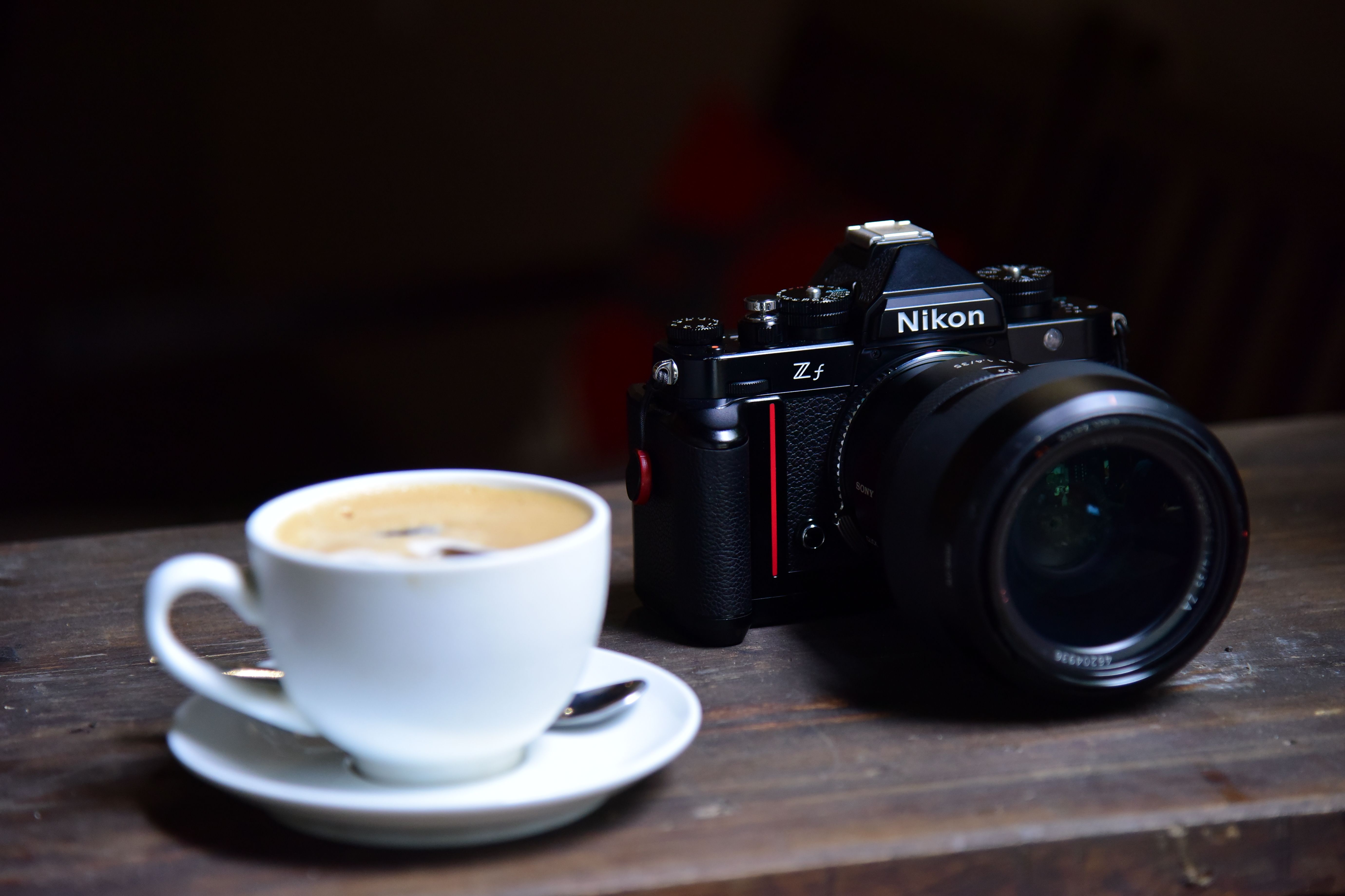 Close-up of Camera with Coffee Cup · Free Stock Photo