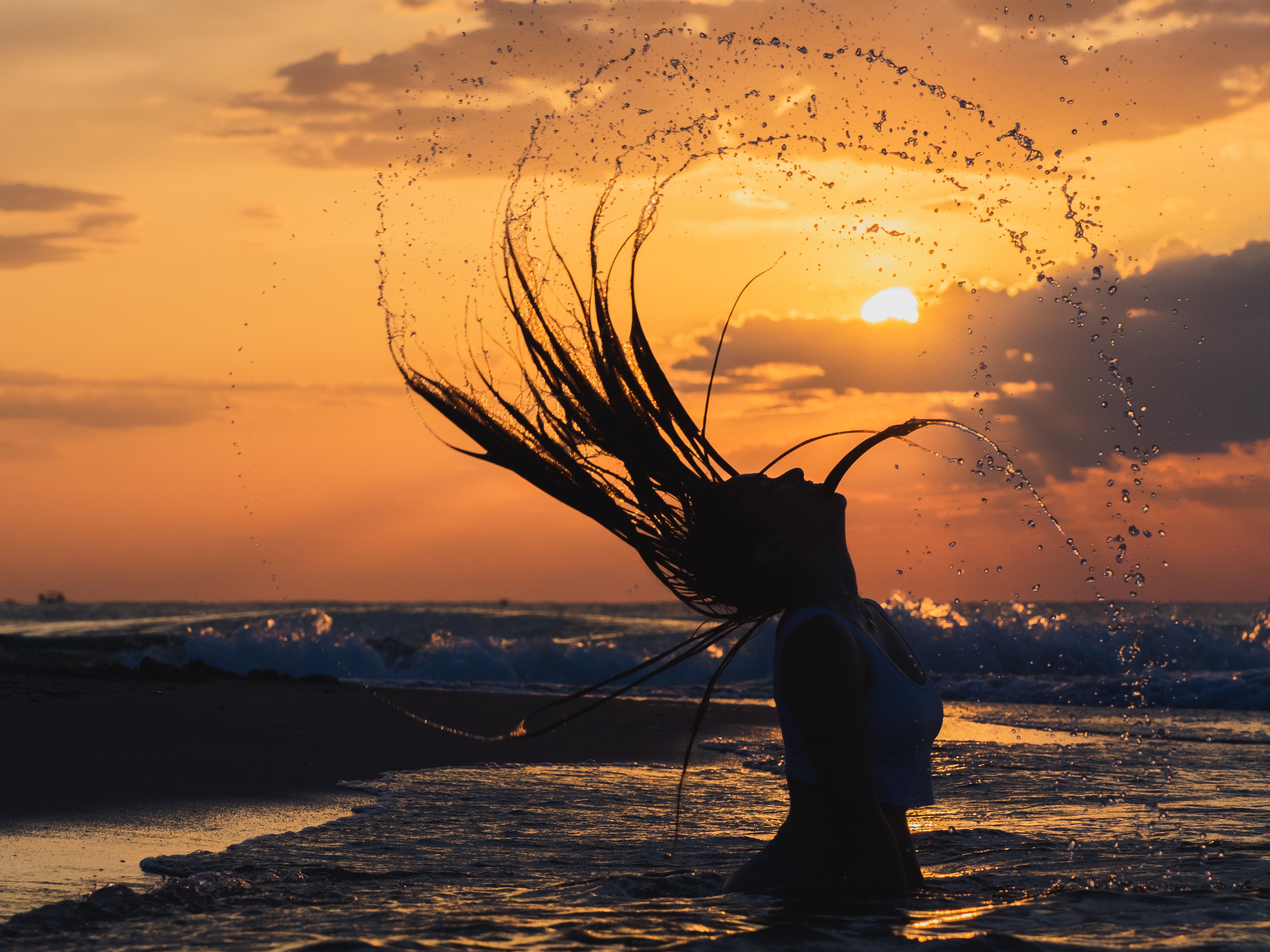 Woman Flipping Hair at Sunset Beach · Free Stock Photo