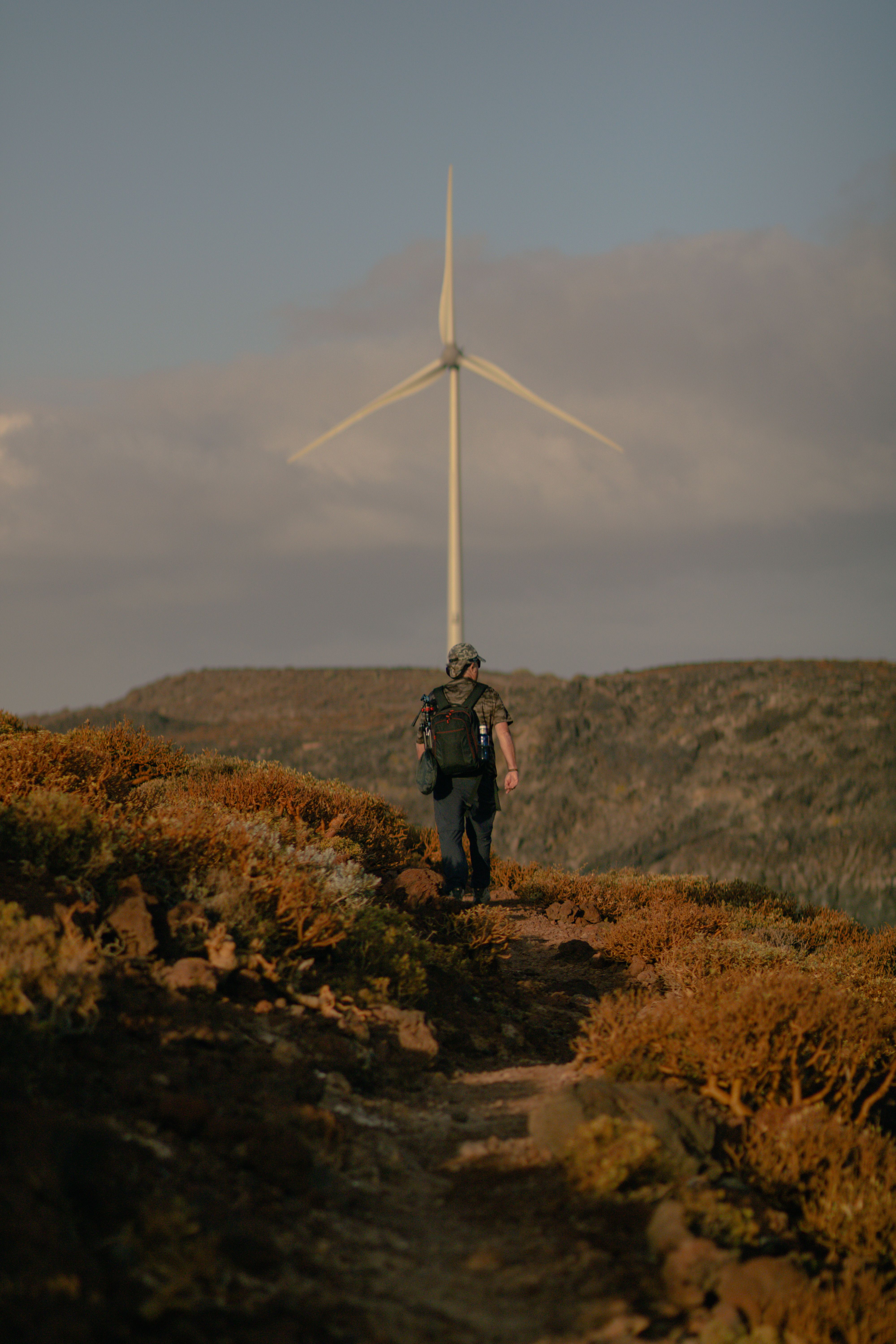 Hiker on Trail Towards Wind Turbine in Abades · Free Stock Photo